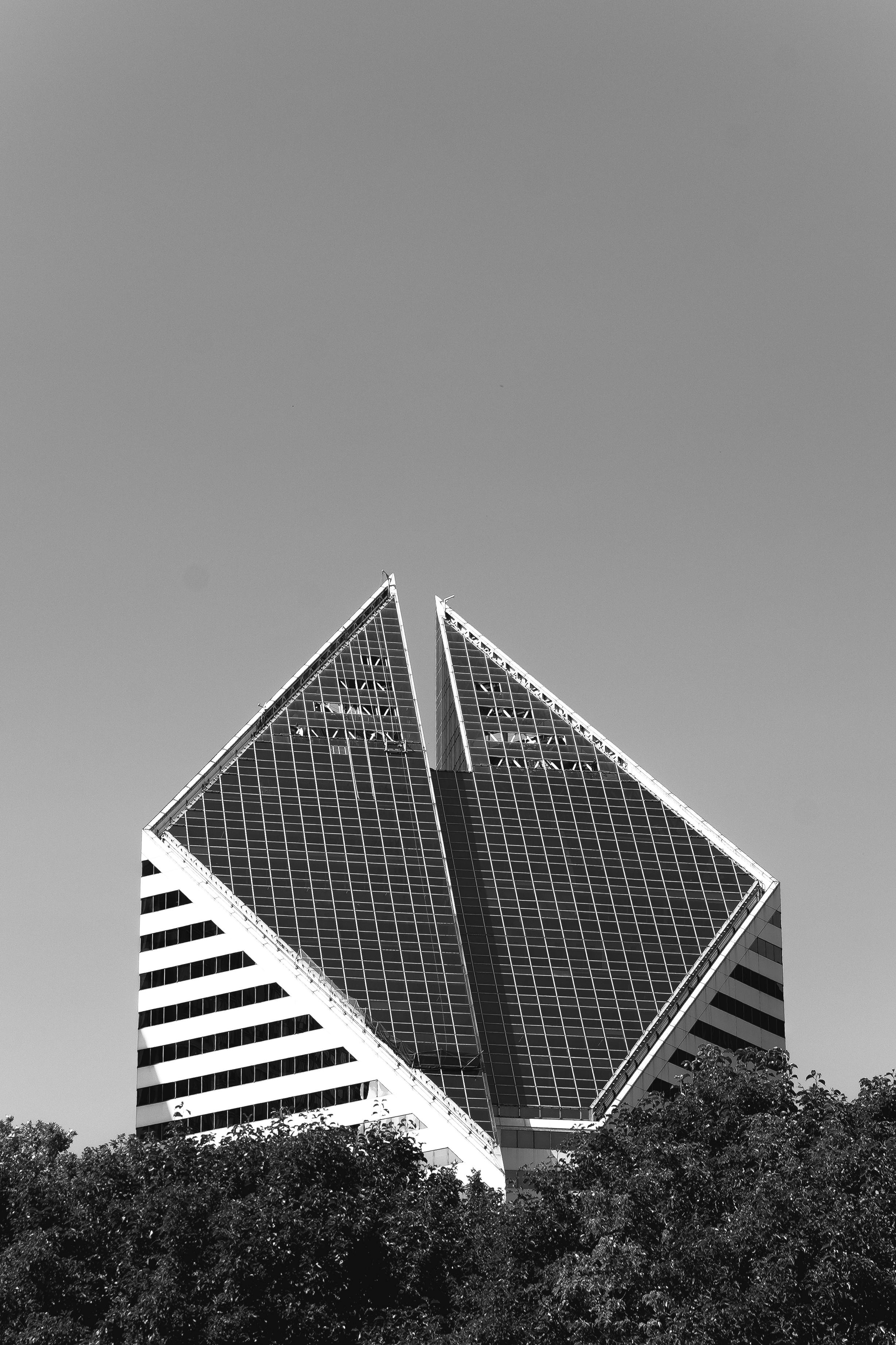Urban futuristic building amidst lush trees · Free Stock Photo