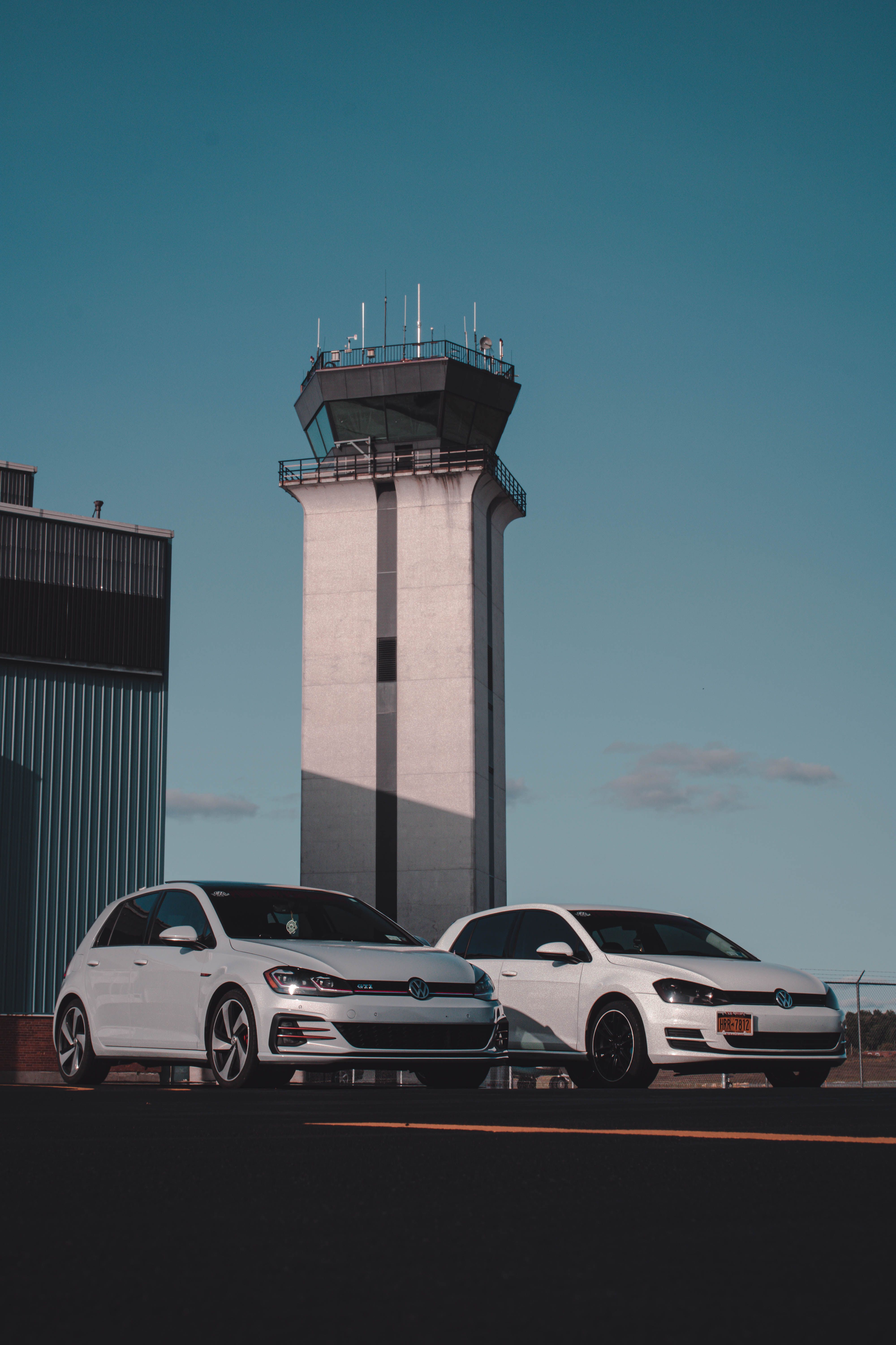 Photograph of Cars Parked Near a Tower · Free Stock Photo