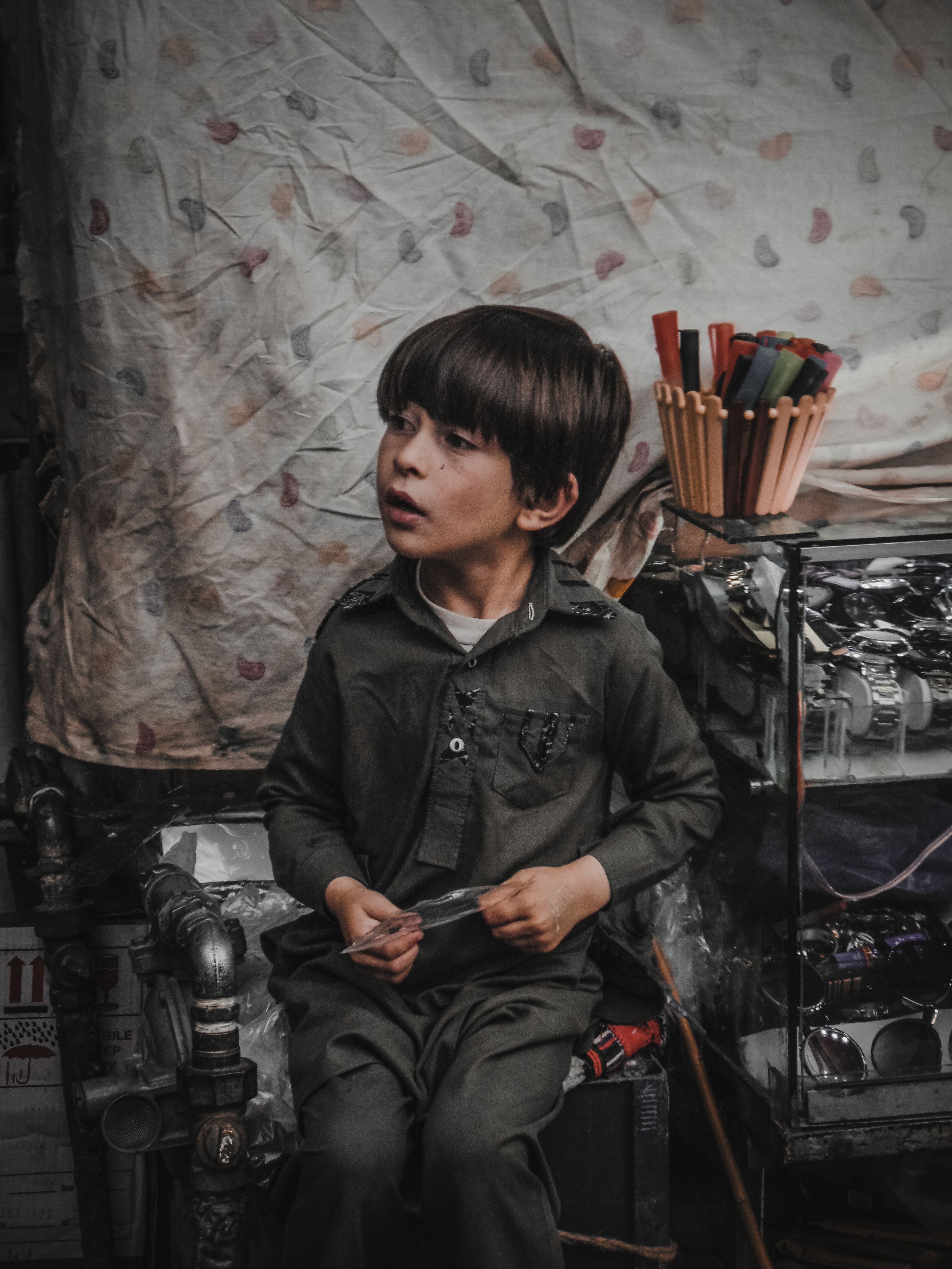 Photograph of a Boy Looking Around · Free Stock Photo