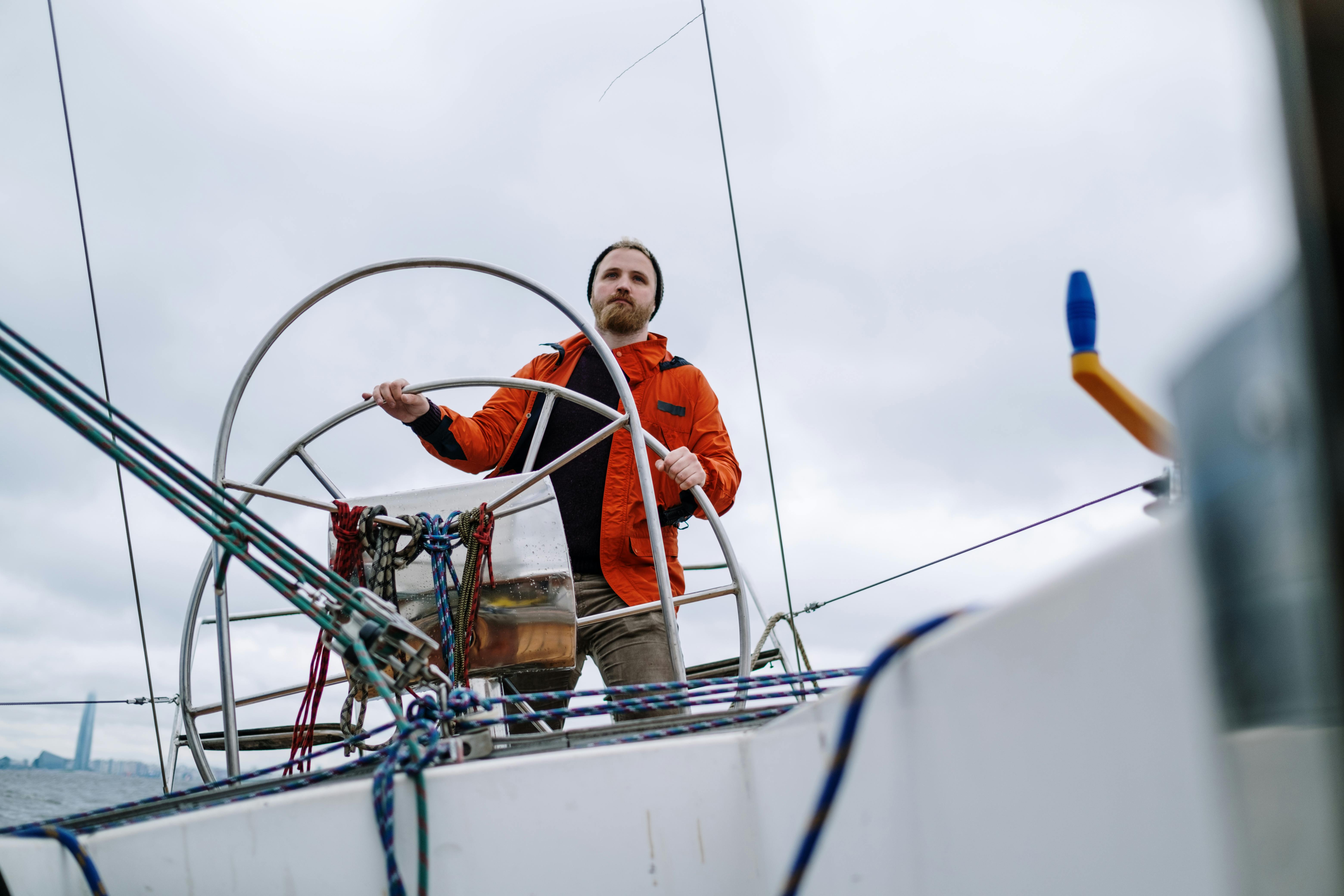 Helmsman Steering a Sailboat · Free Stock Photo