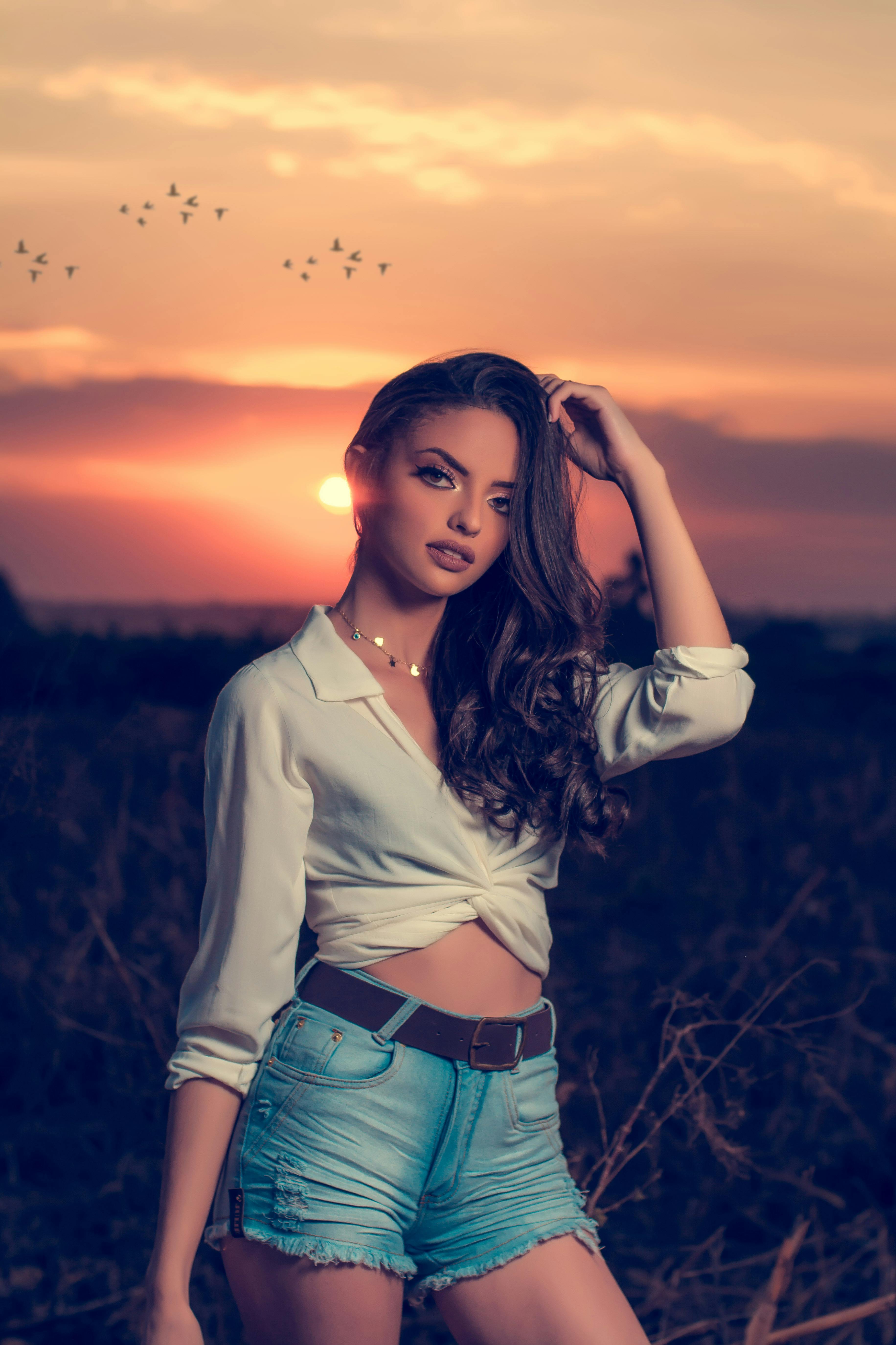 Beautiful Woman Posing Against Sunset · Free Stock Photo