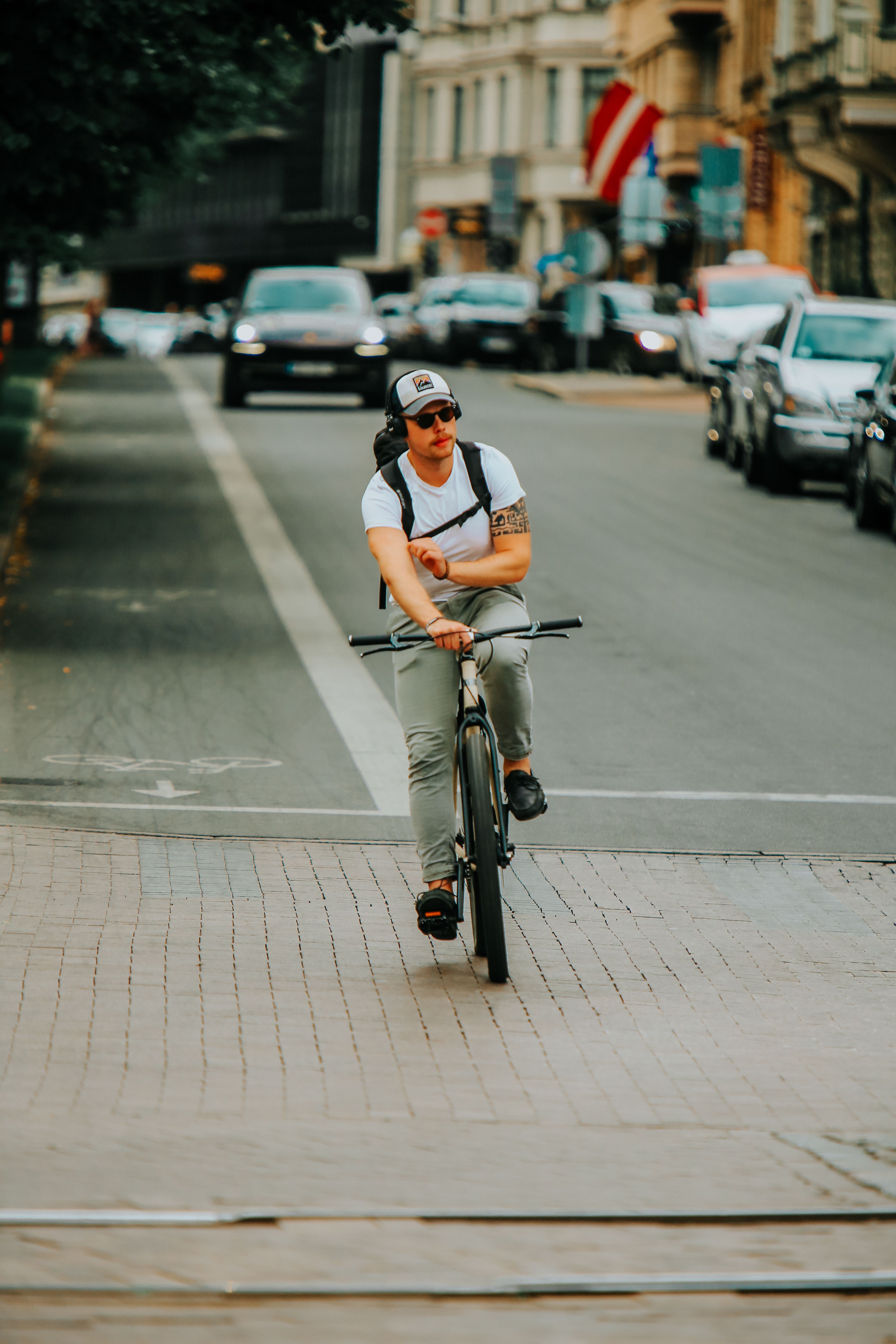 A Man on a Bicycle in a City · Free Stock Photo