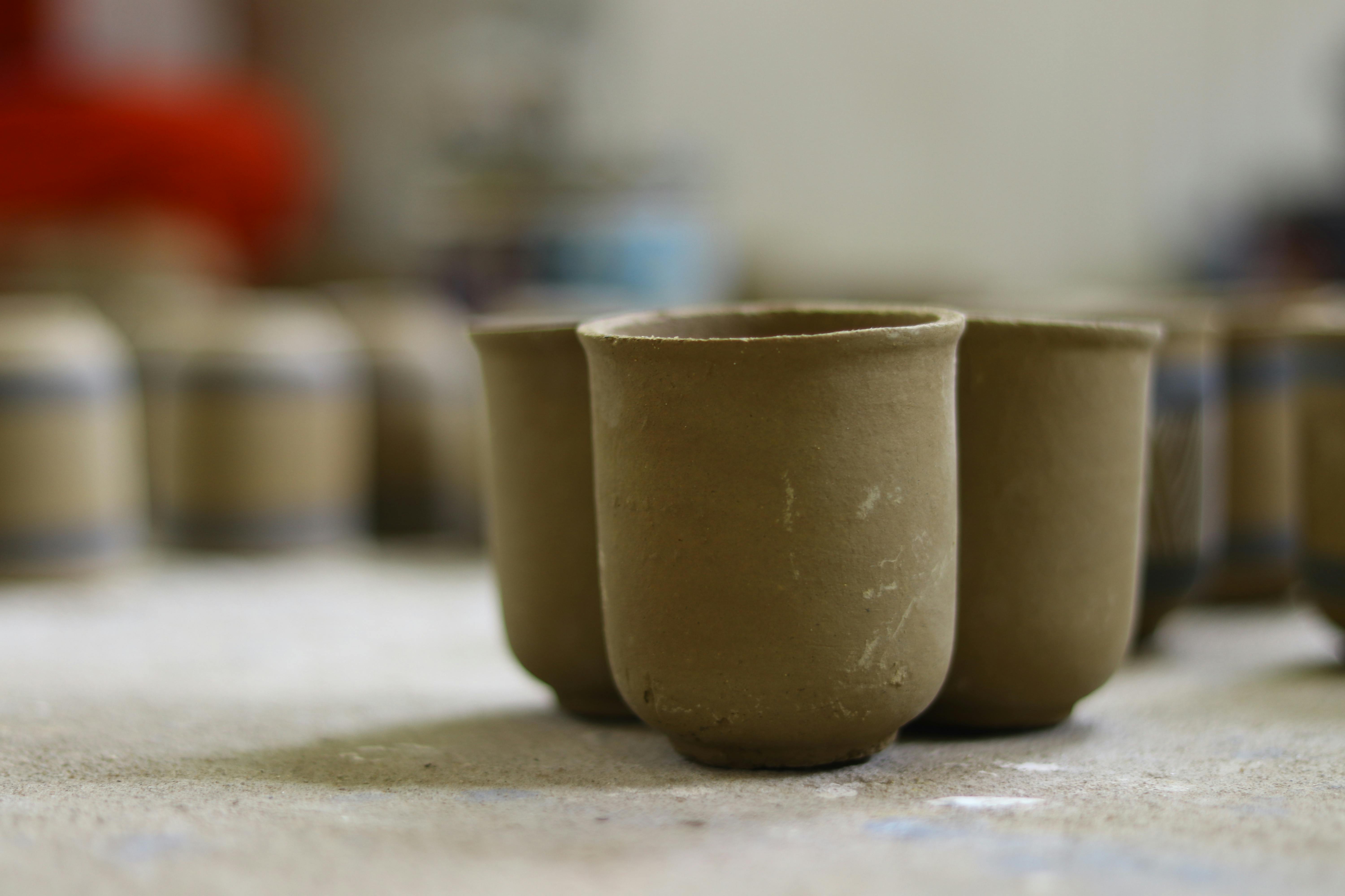 Clay Cups on a Concrete Surface · Free Stock Photo