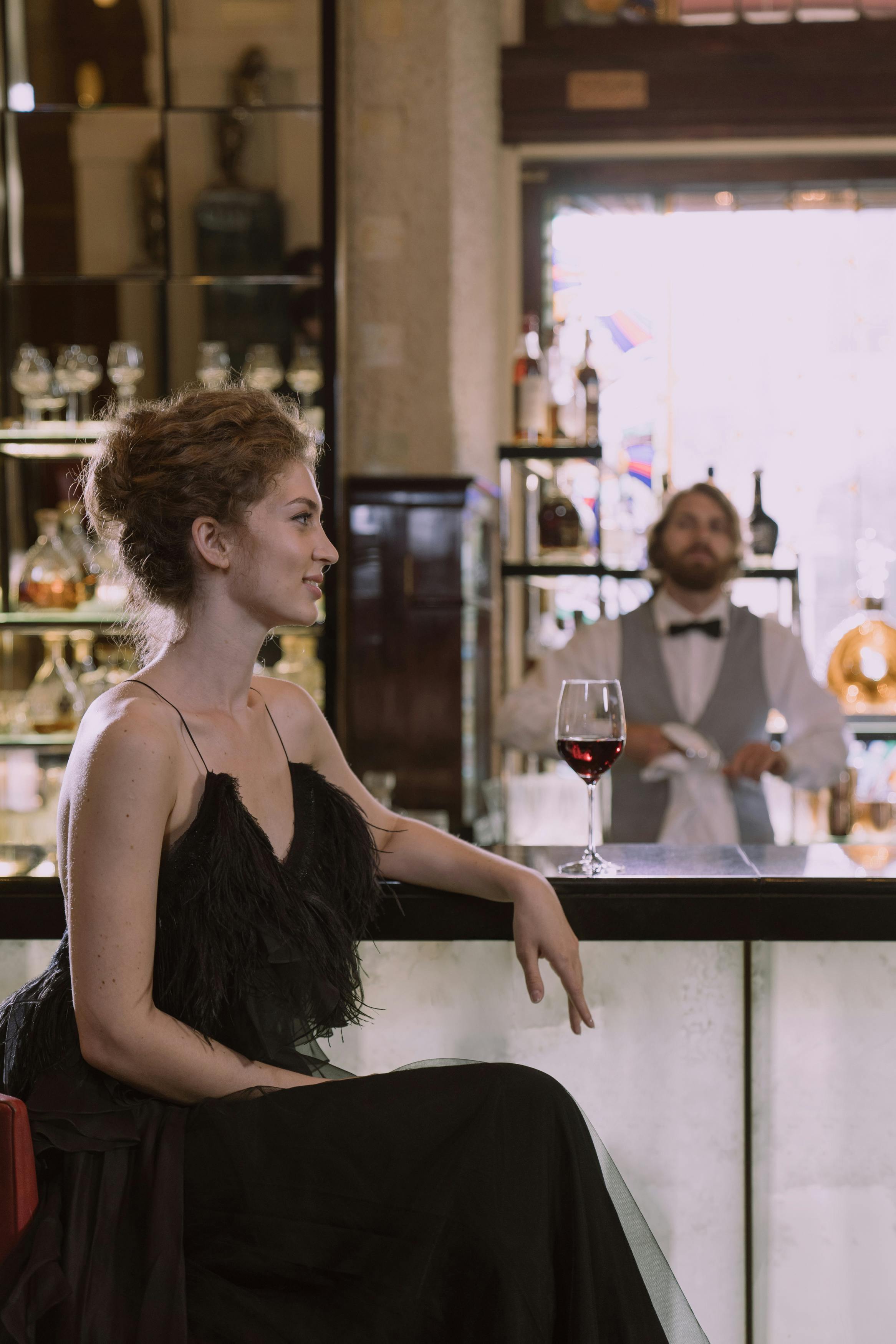 Beautiful Woman in Black Dress Sitting at the Bar Counter · Free Stock ...