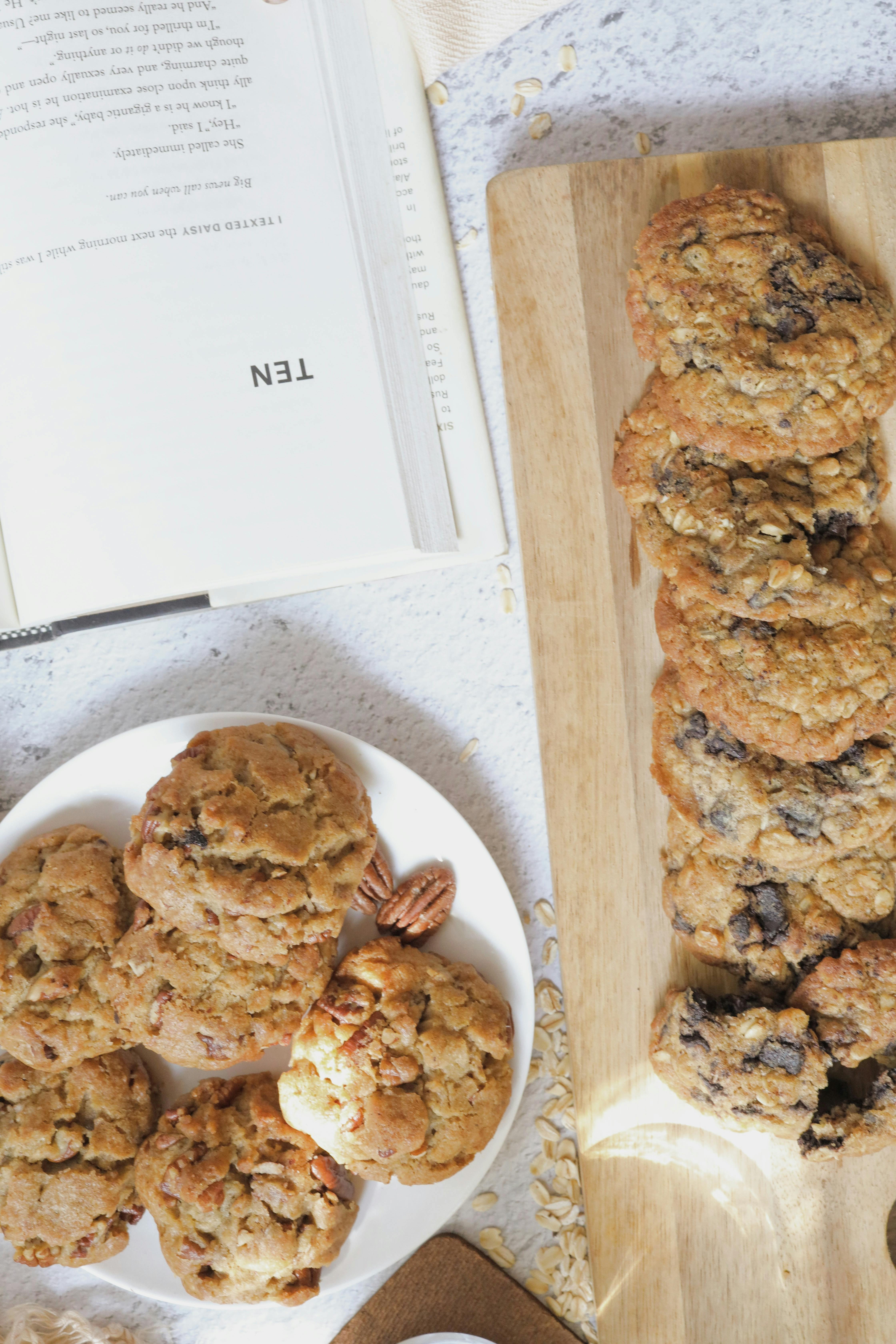 Cookies and a Book on White Surface · Free Stock Photo