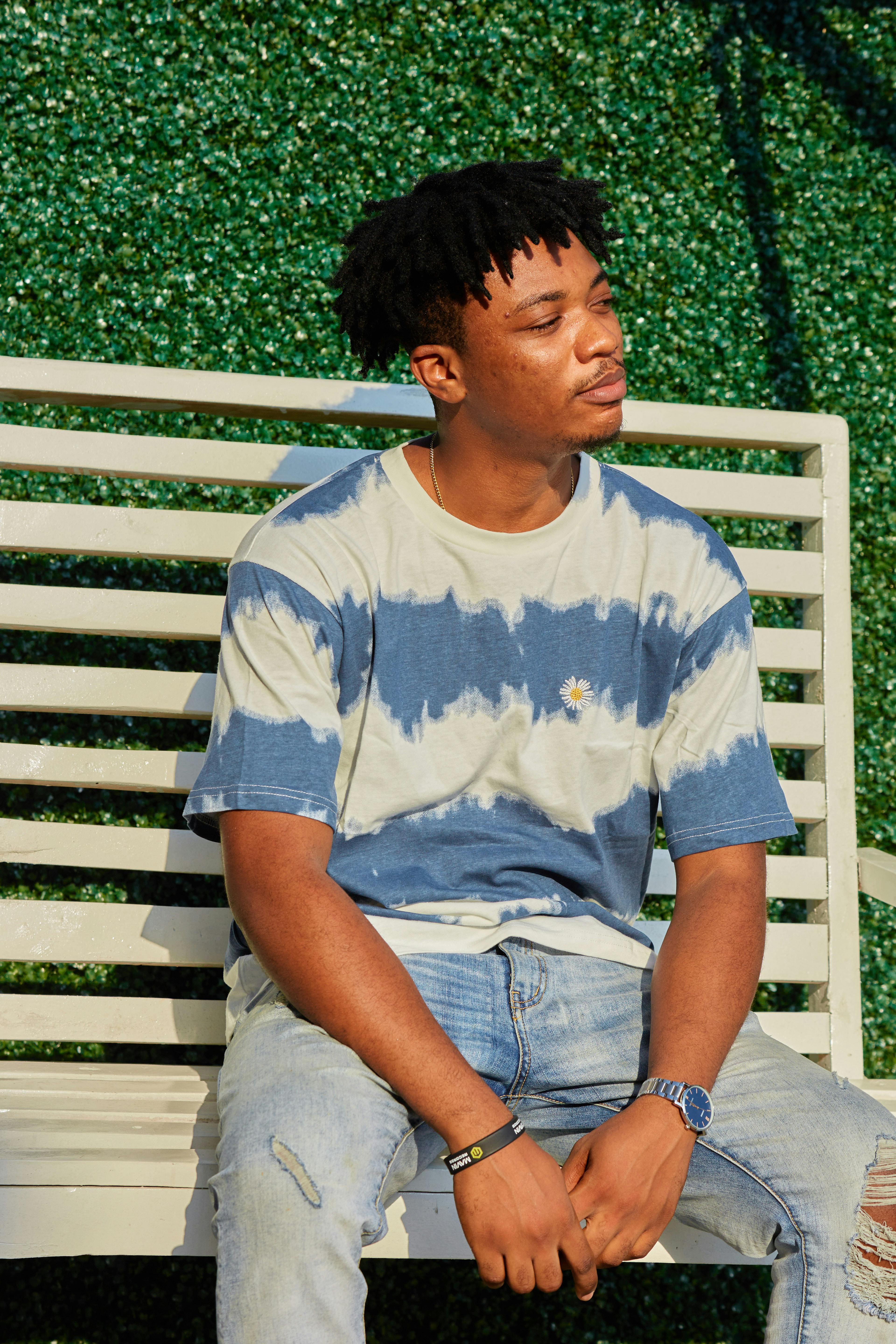 Man Looking Afar While Sitting on Wooden Bench · Free Stock Photo
