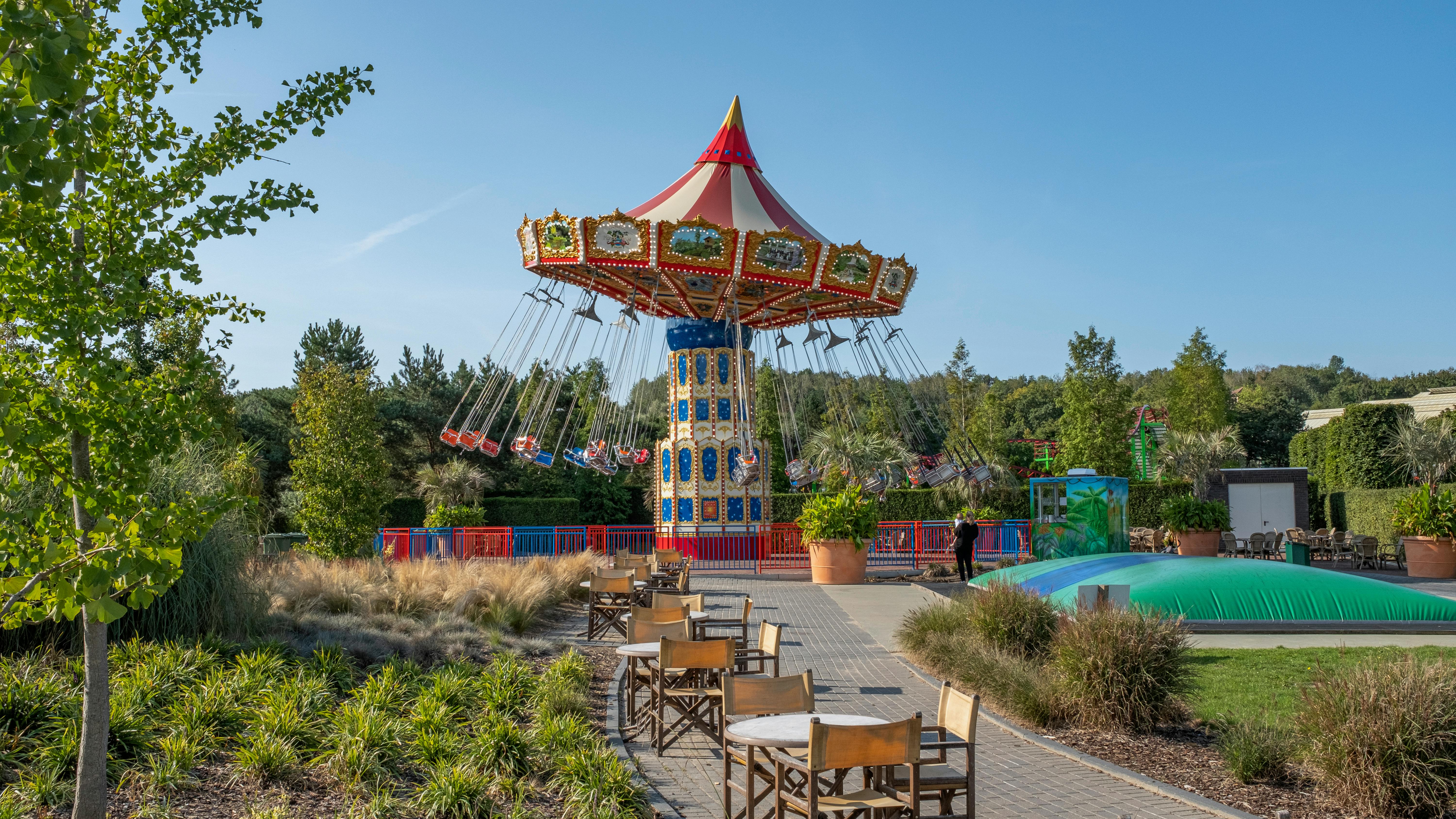 Colorful Carousel Surrounded by Green Trees · Free Stock Photo