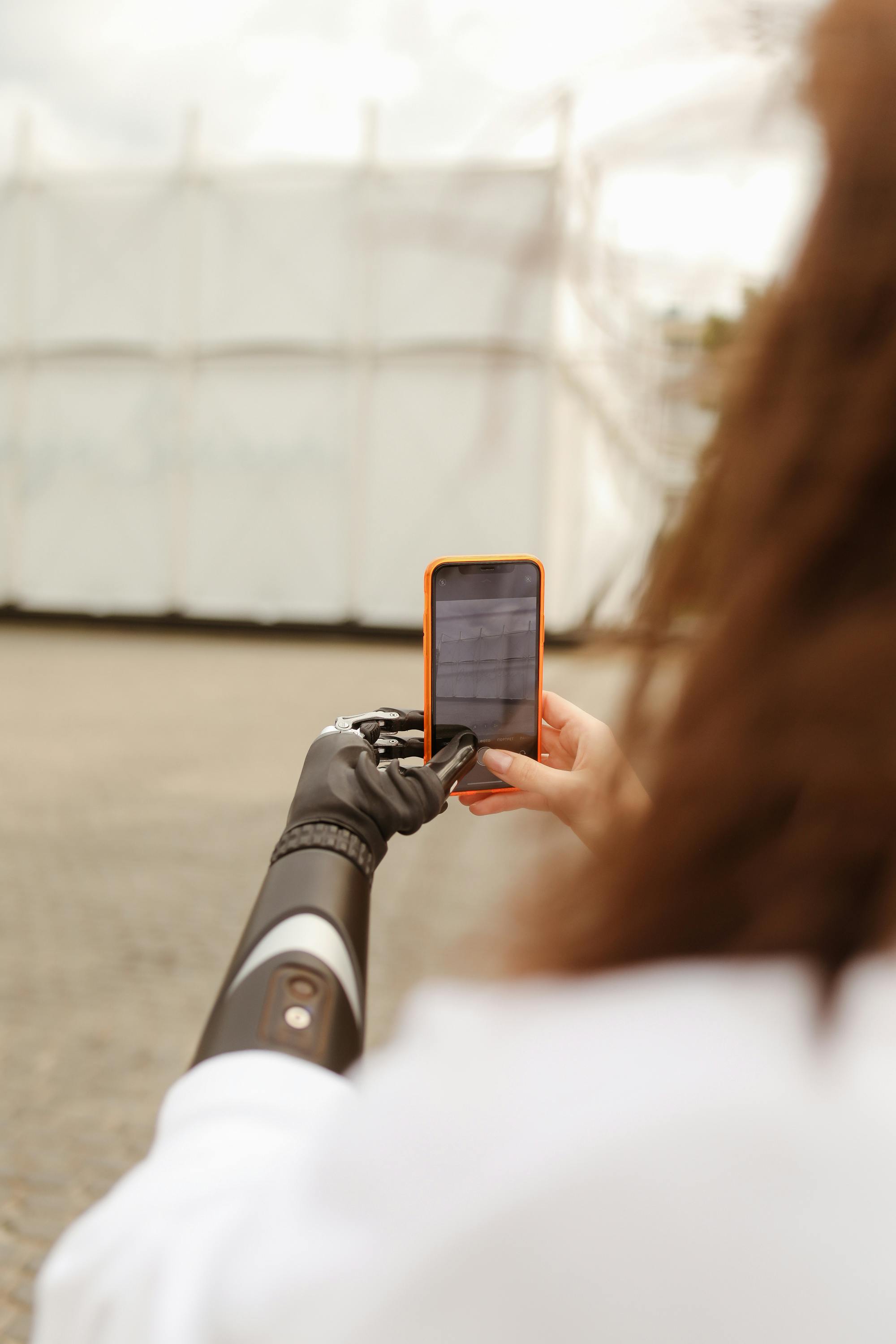 Woman with Prosthetic Arm Holding Phone · Free Stock Photo