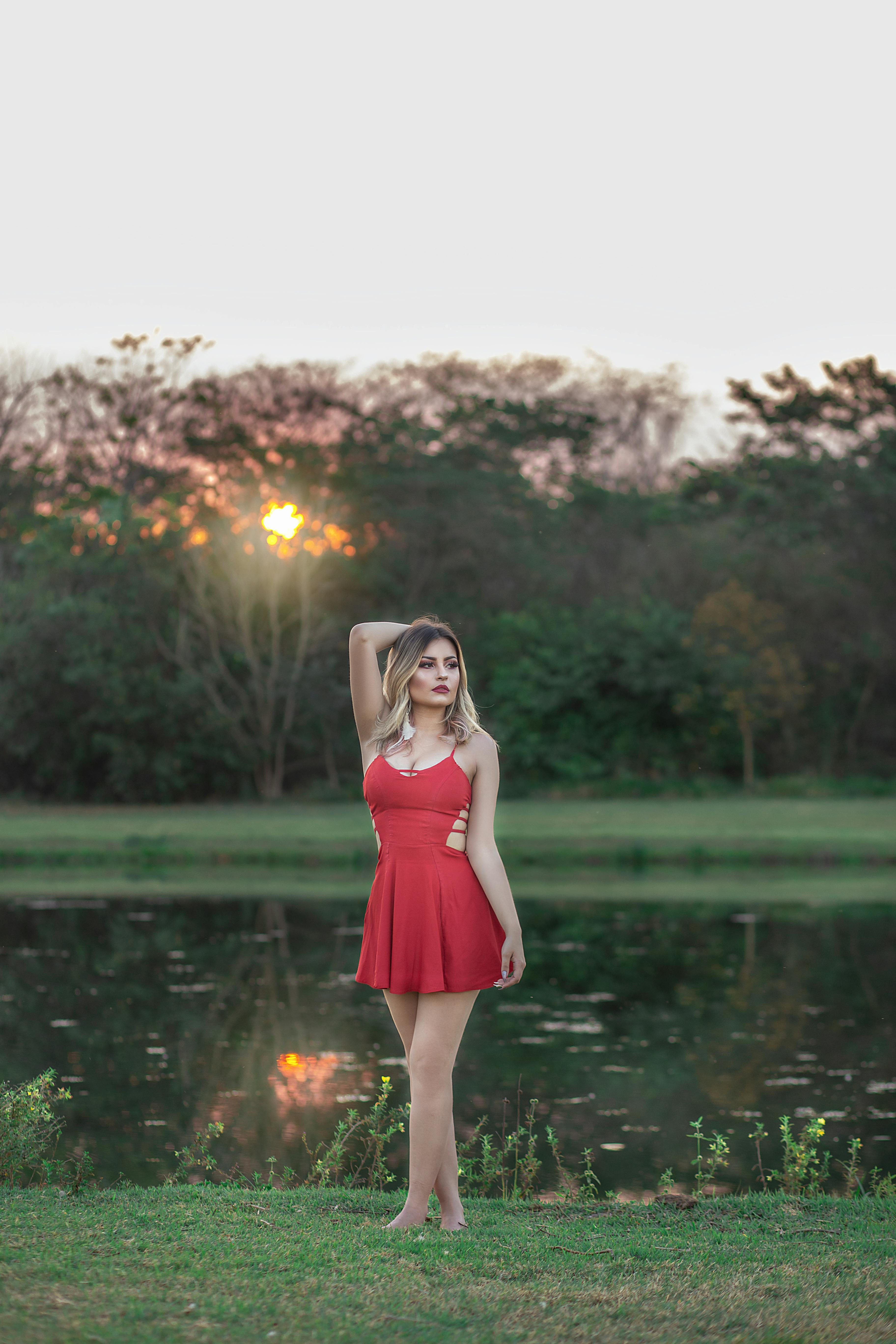Woman in Red Dress Standing on Grass · Free Stock Photo