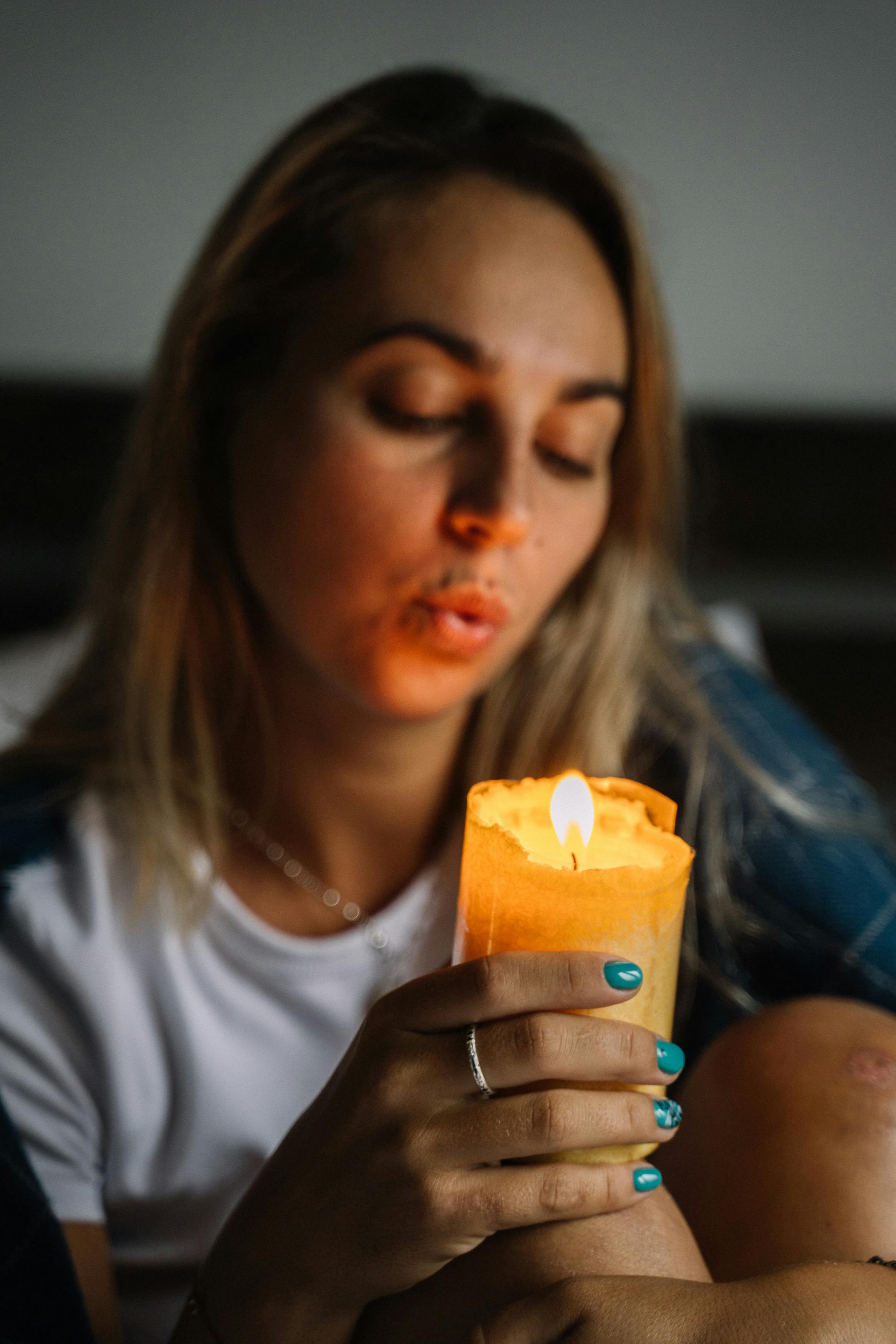 Woman Holding a Lighted Candle · Free Stock Photo