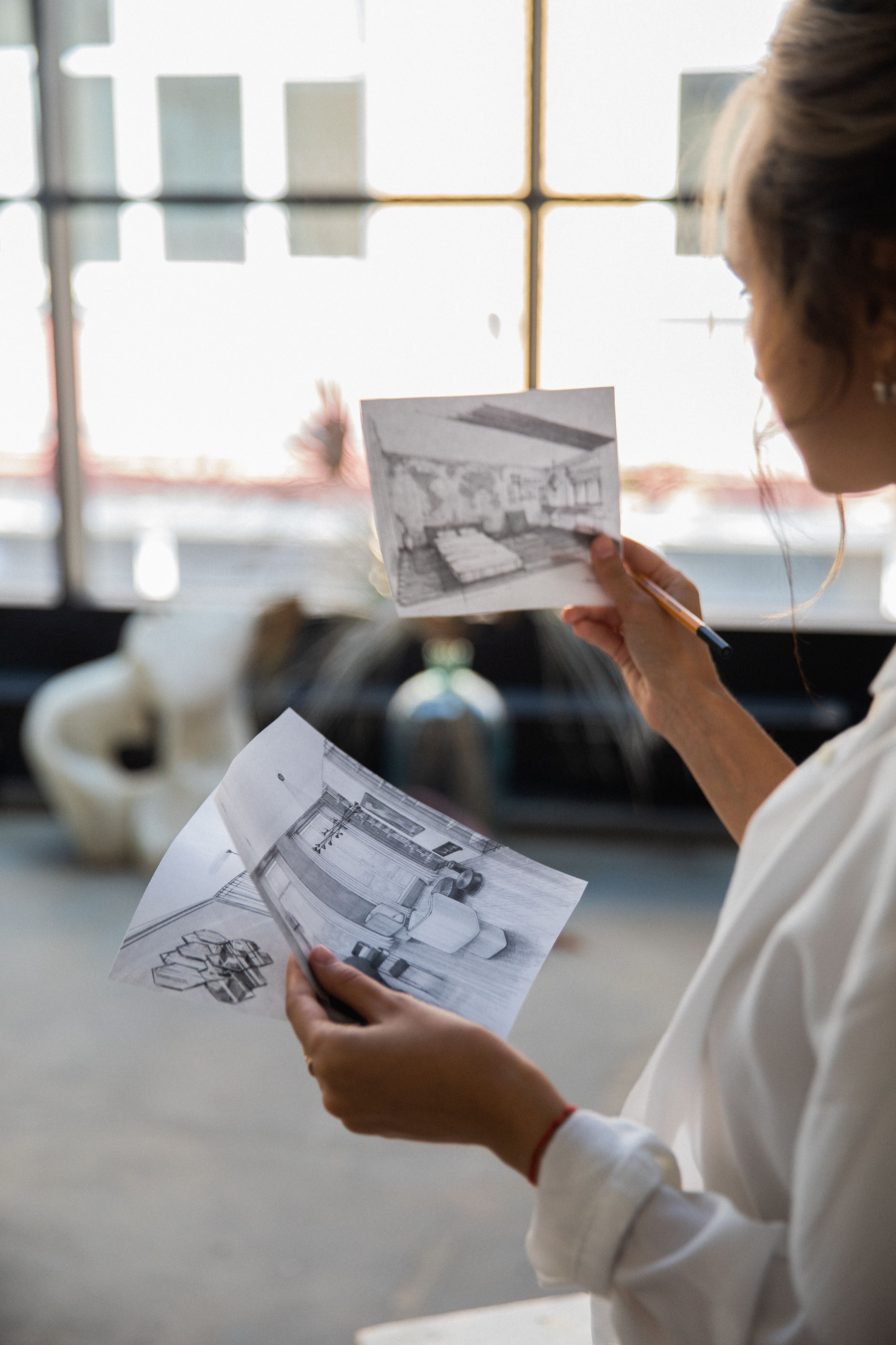 Shot of Woman Holding Pencil Drawings · Free Stock Photo