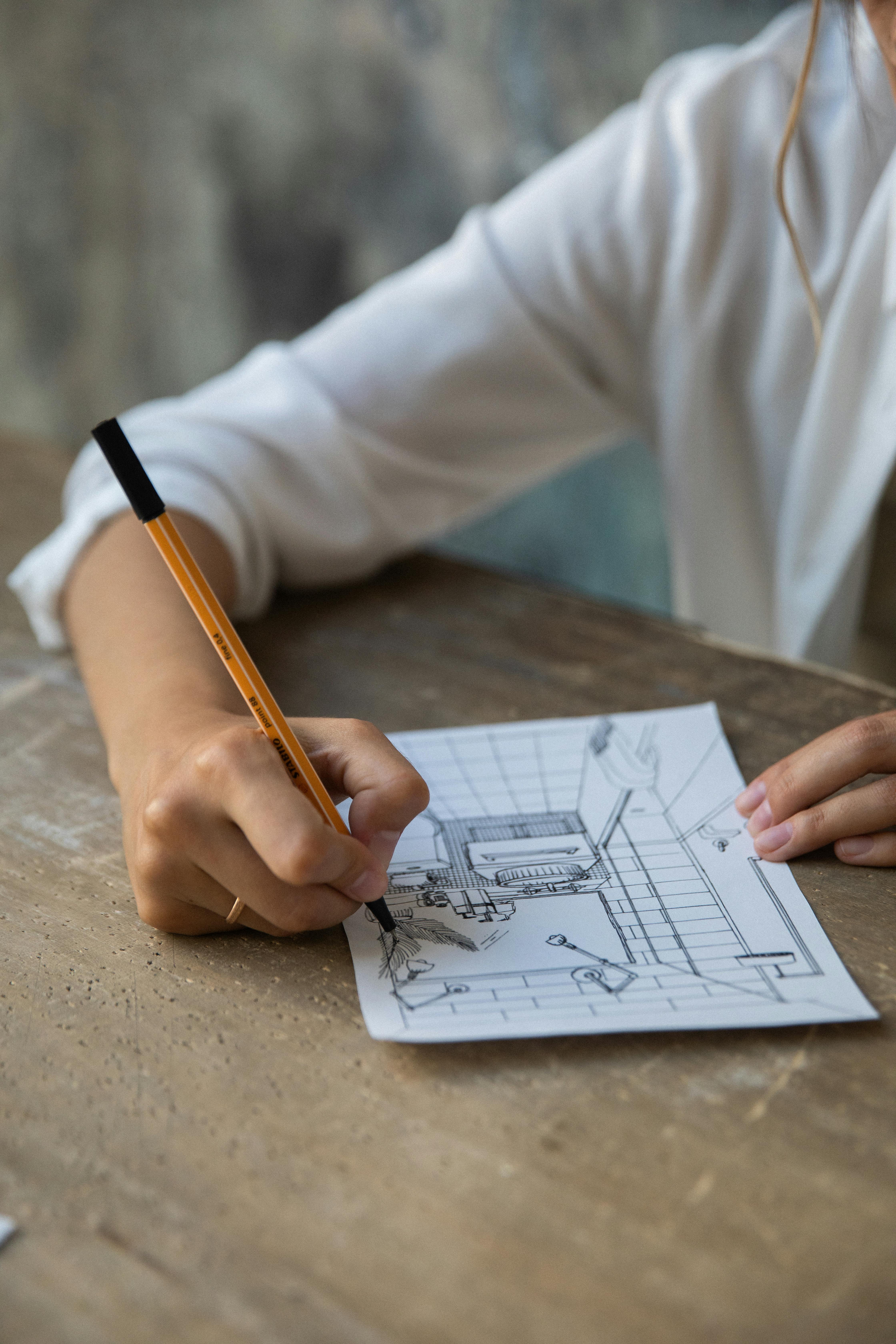 Person Drawing on White Paper · Free Stock Photo