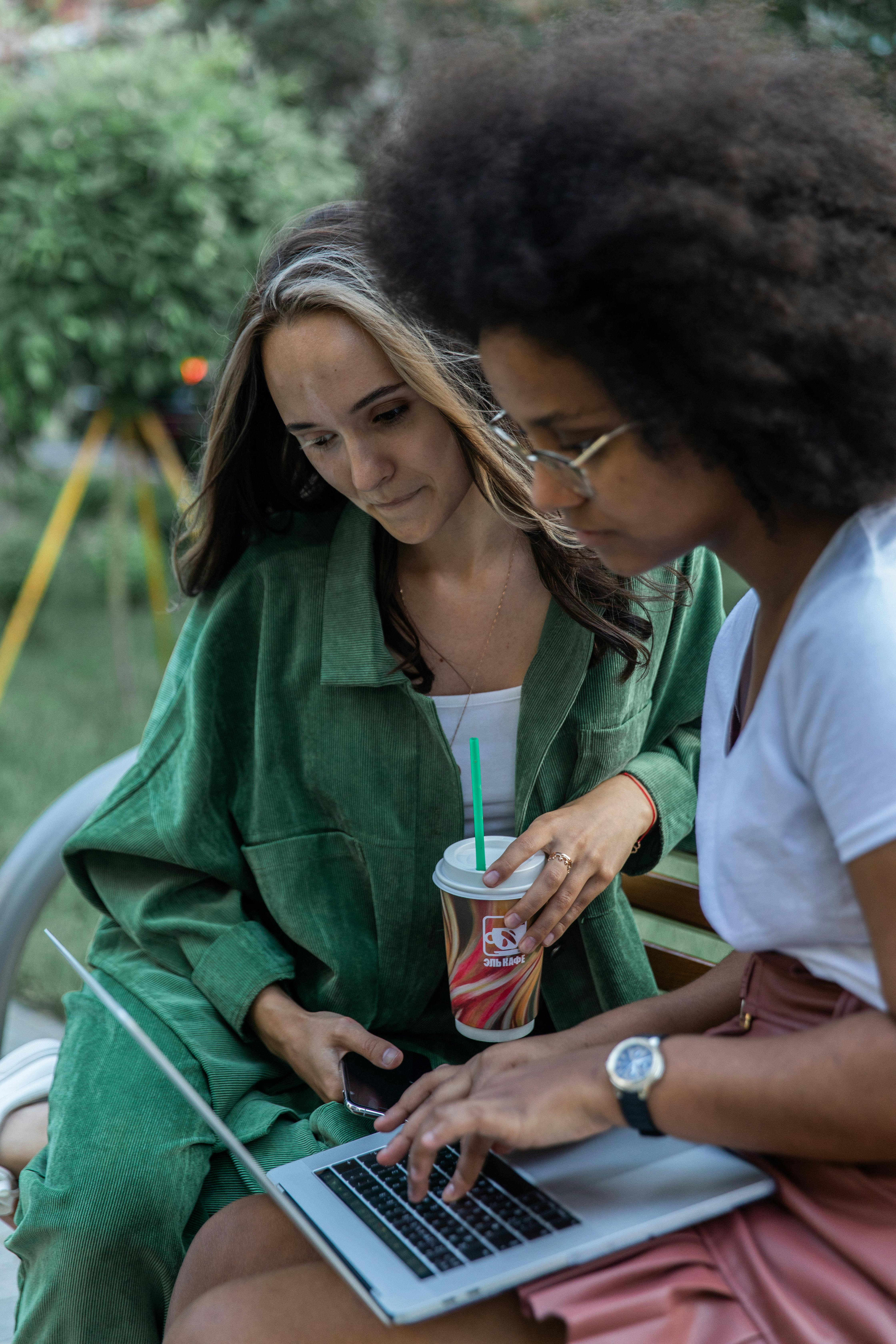 Two Women Looking at a Laptop · Free Stock Photo