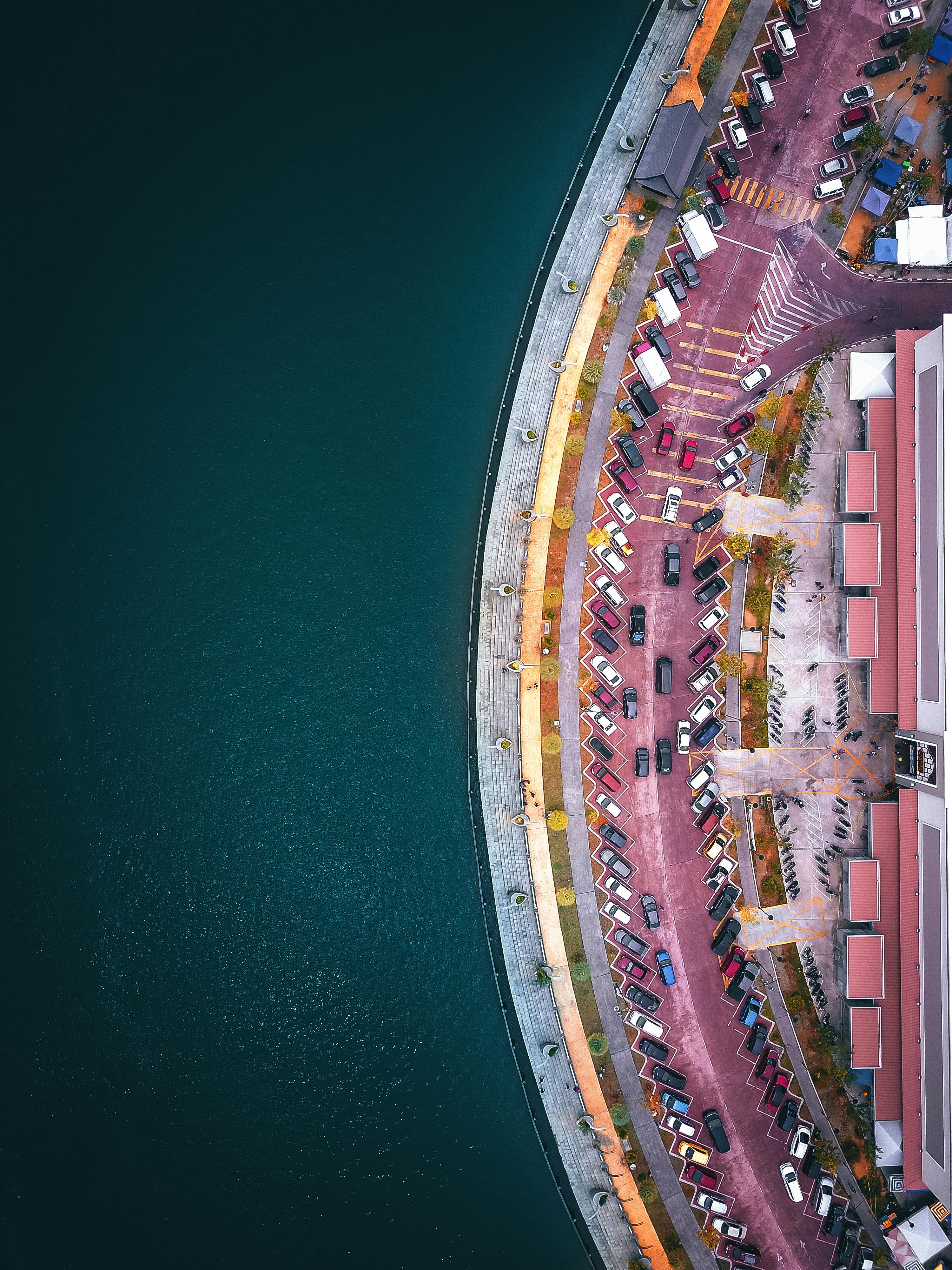 Modern city embankment with road near calm seawater · Free Stock Photo