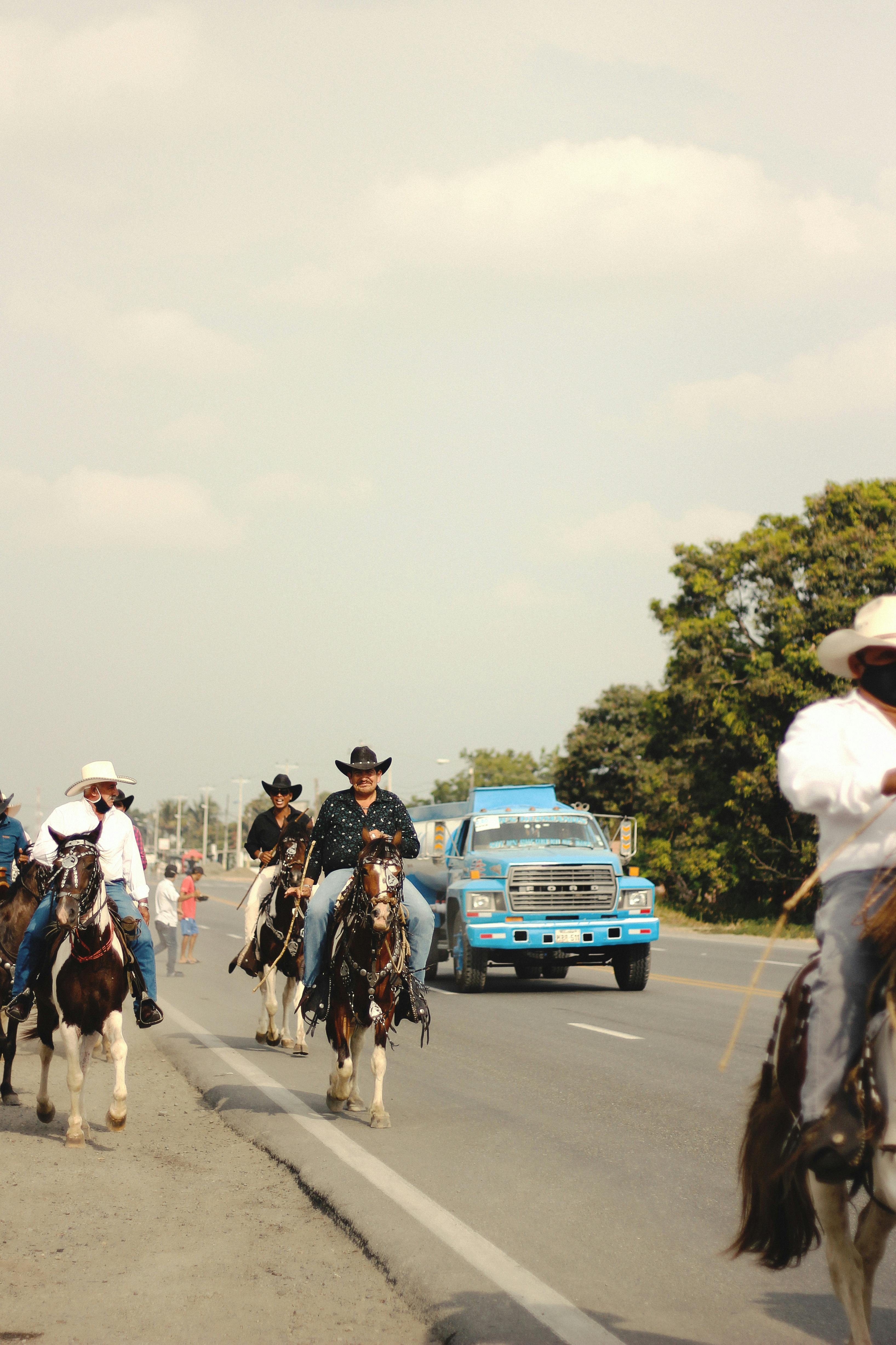 People Riding Horses on Street · Free Stock Photo