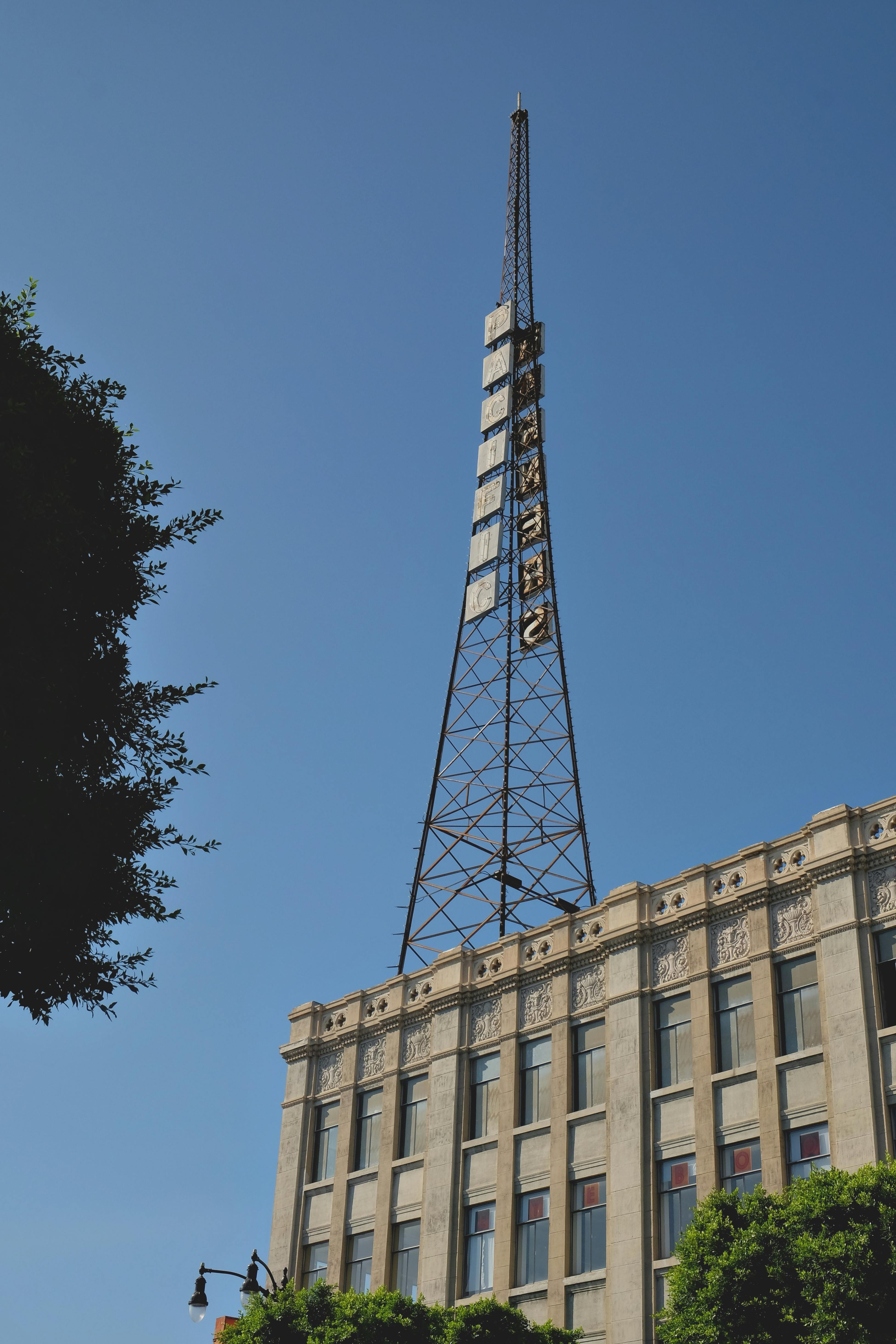 Lace Metal Tower and Beige Building Facade · Free Stock Photo