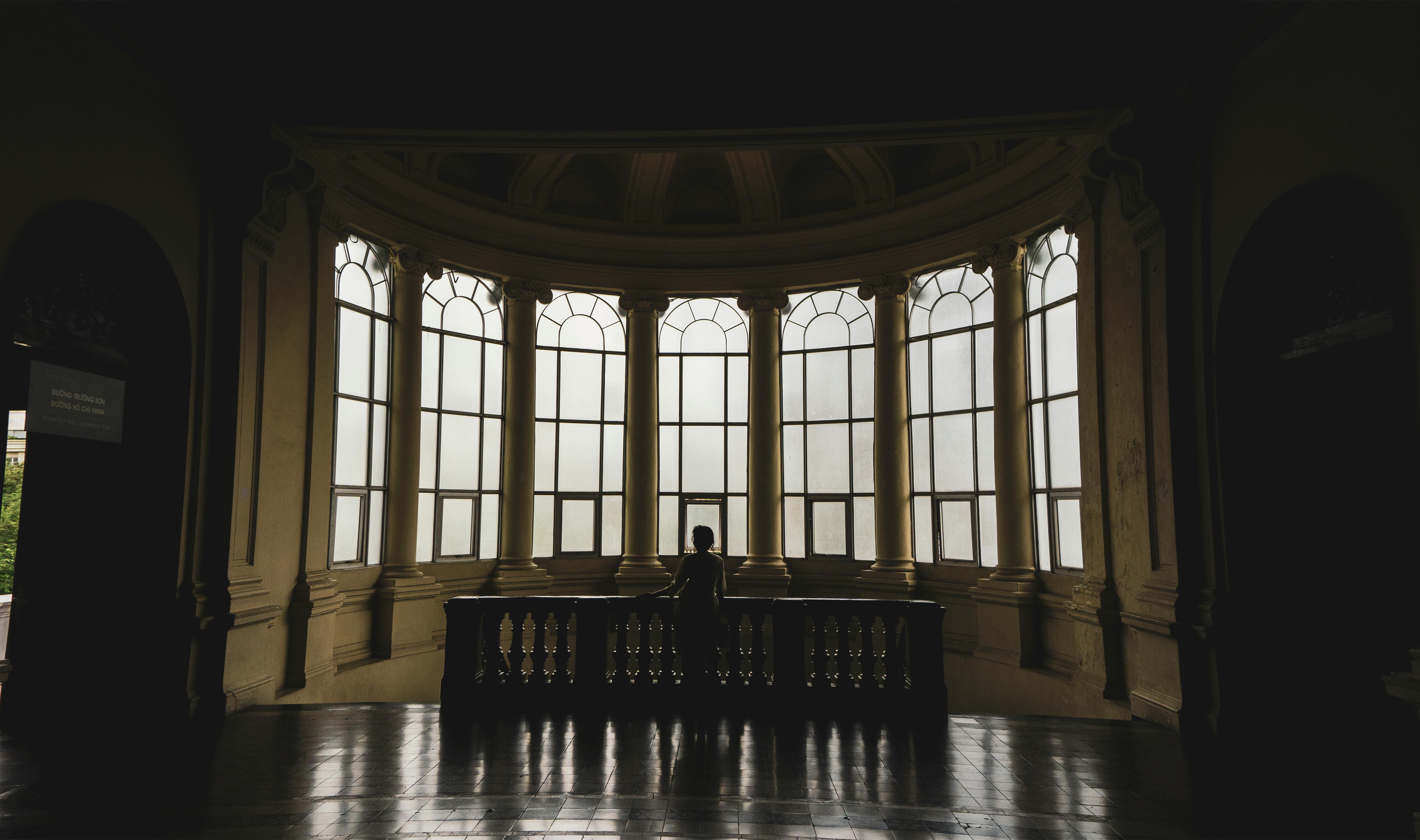 Old Woman Walking in Doors with Stained Glass Windows · Free Stock Photo