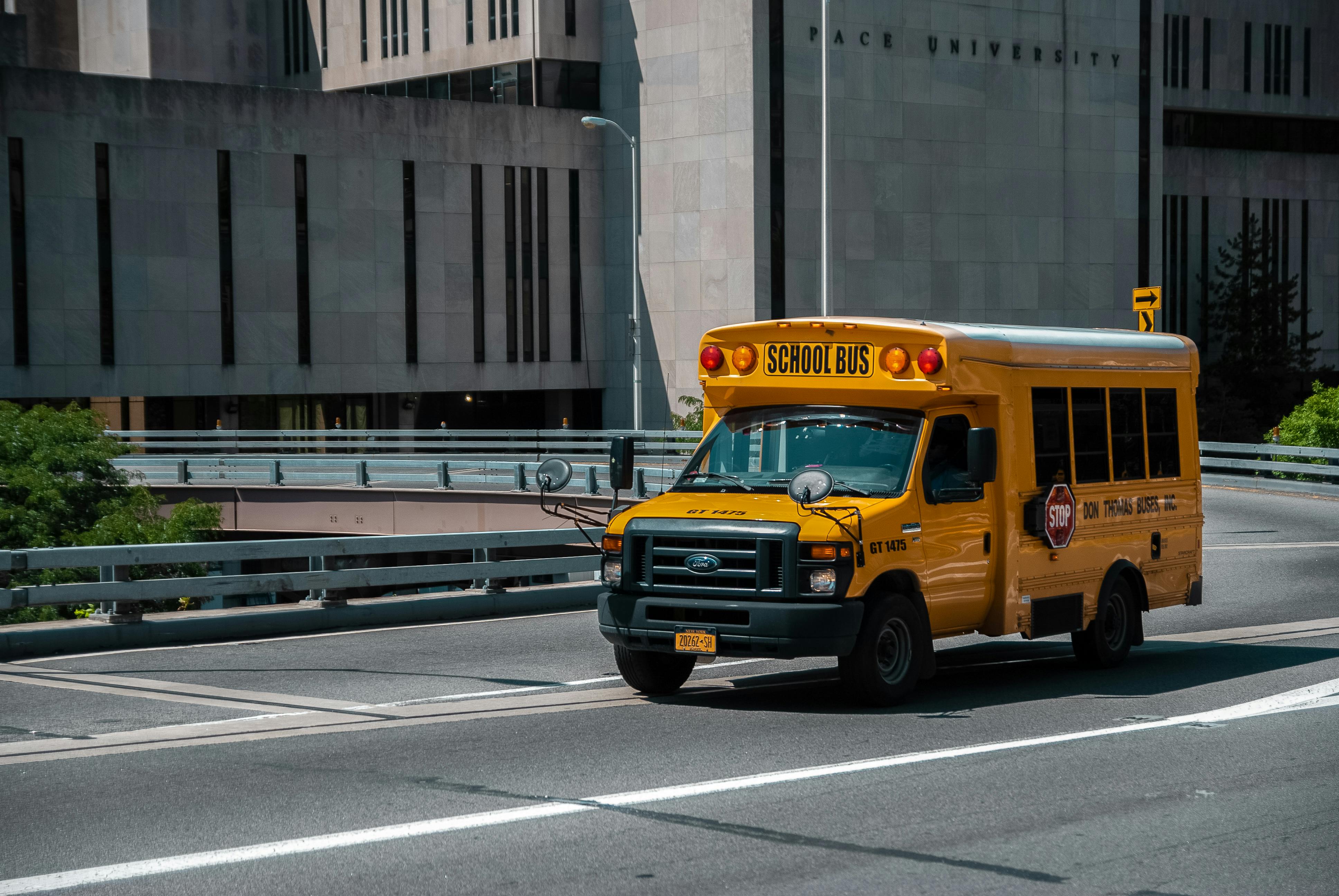 Yellow School Bus on Road · Free Stock Photo