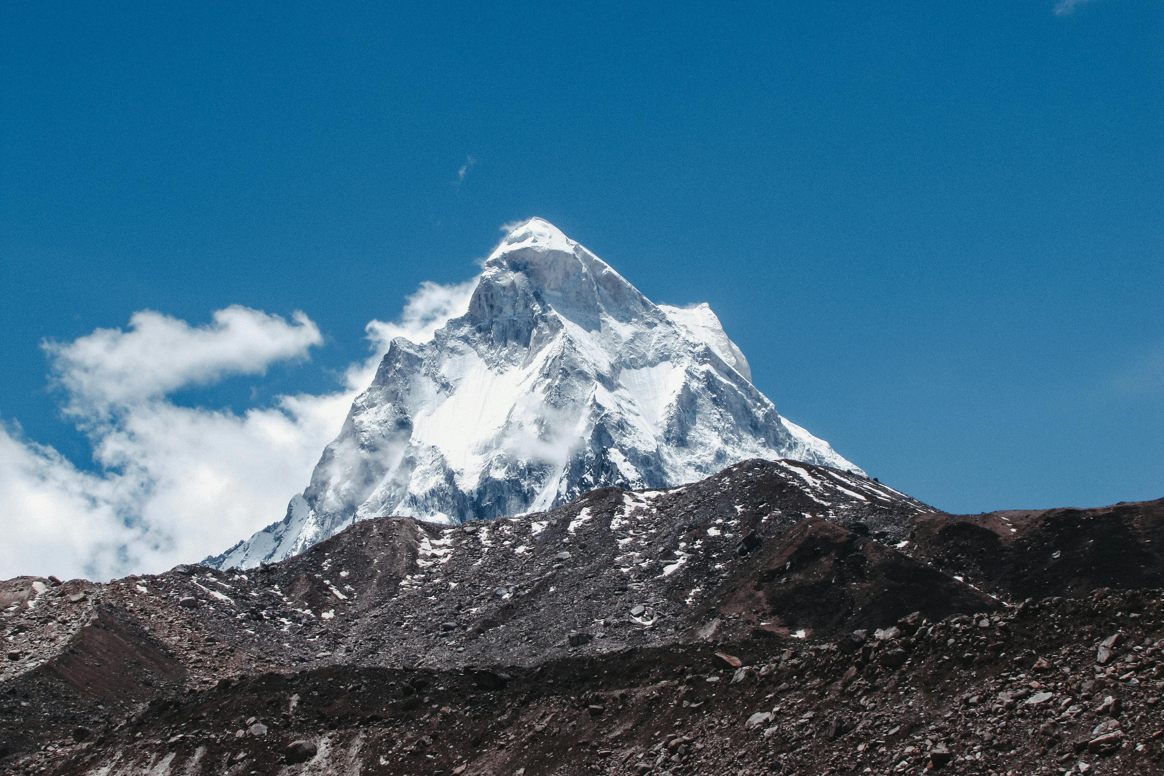 Sharp Rocky Mountain Peak and Rock in Pond · Free Stock Photo