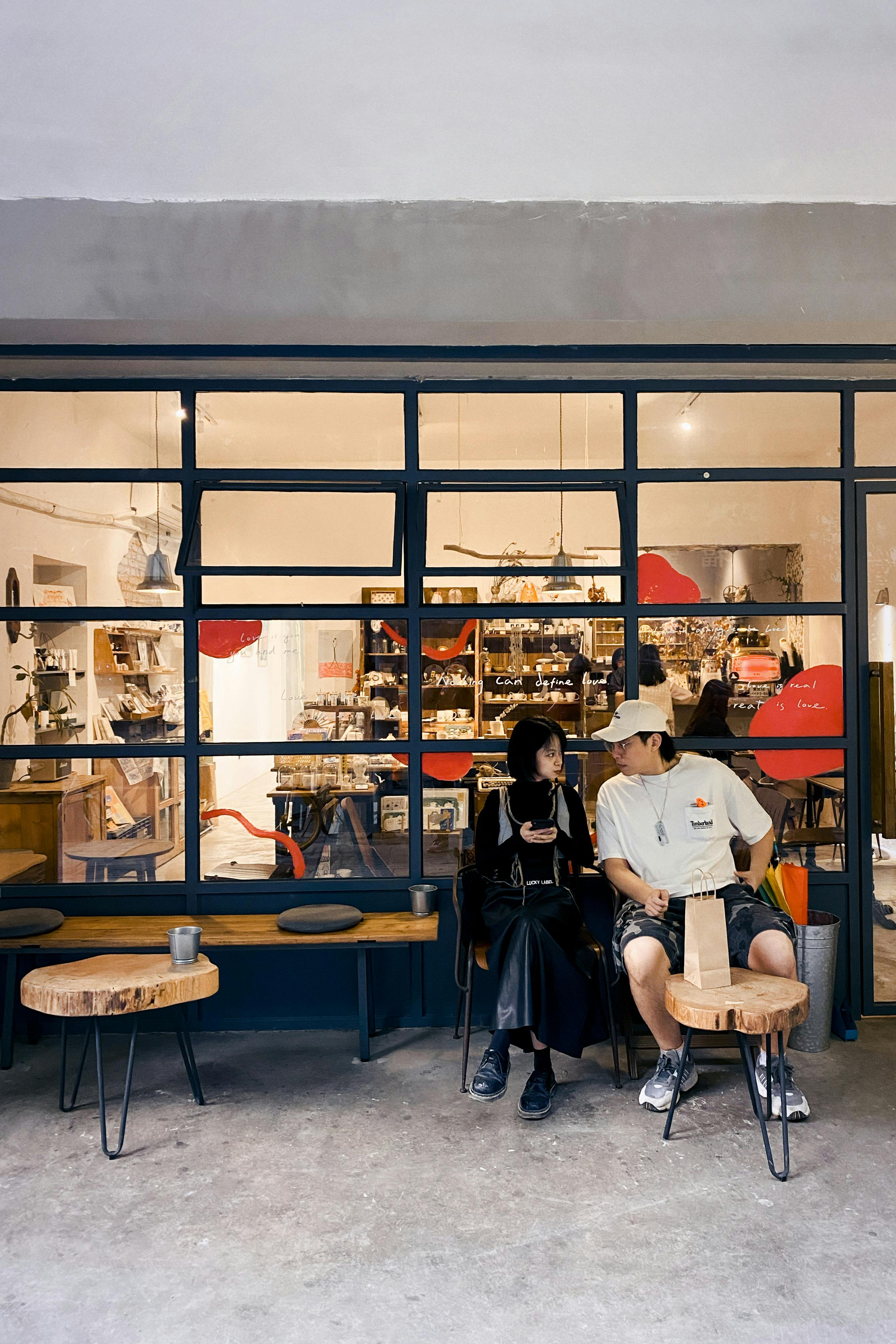 Couple Sitting Outside Shop · Free Stock Photo