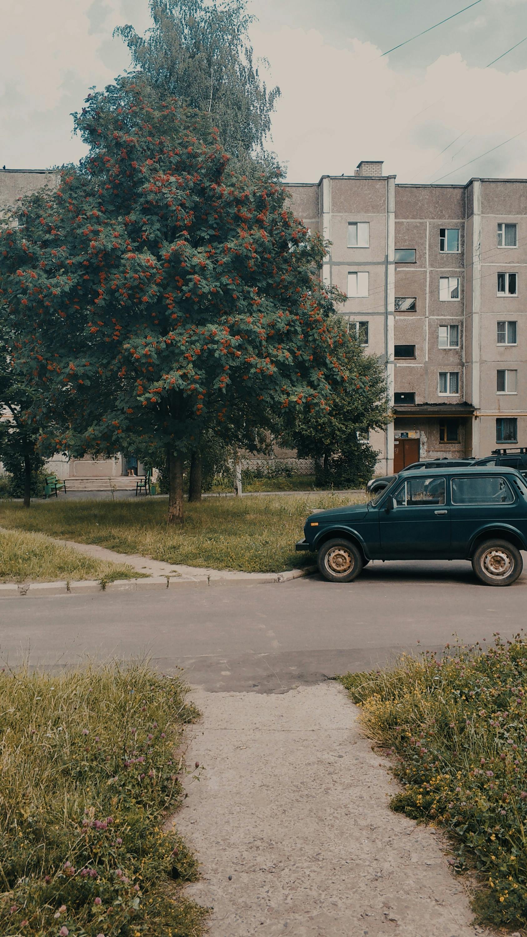 Car Parked Outside of an Apartment Building · Free Stock Photo