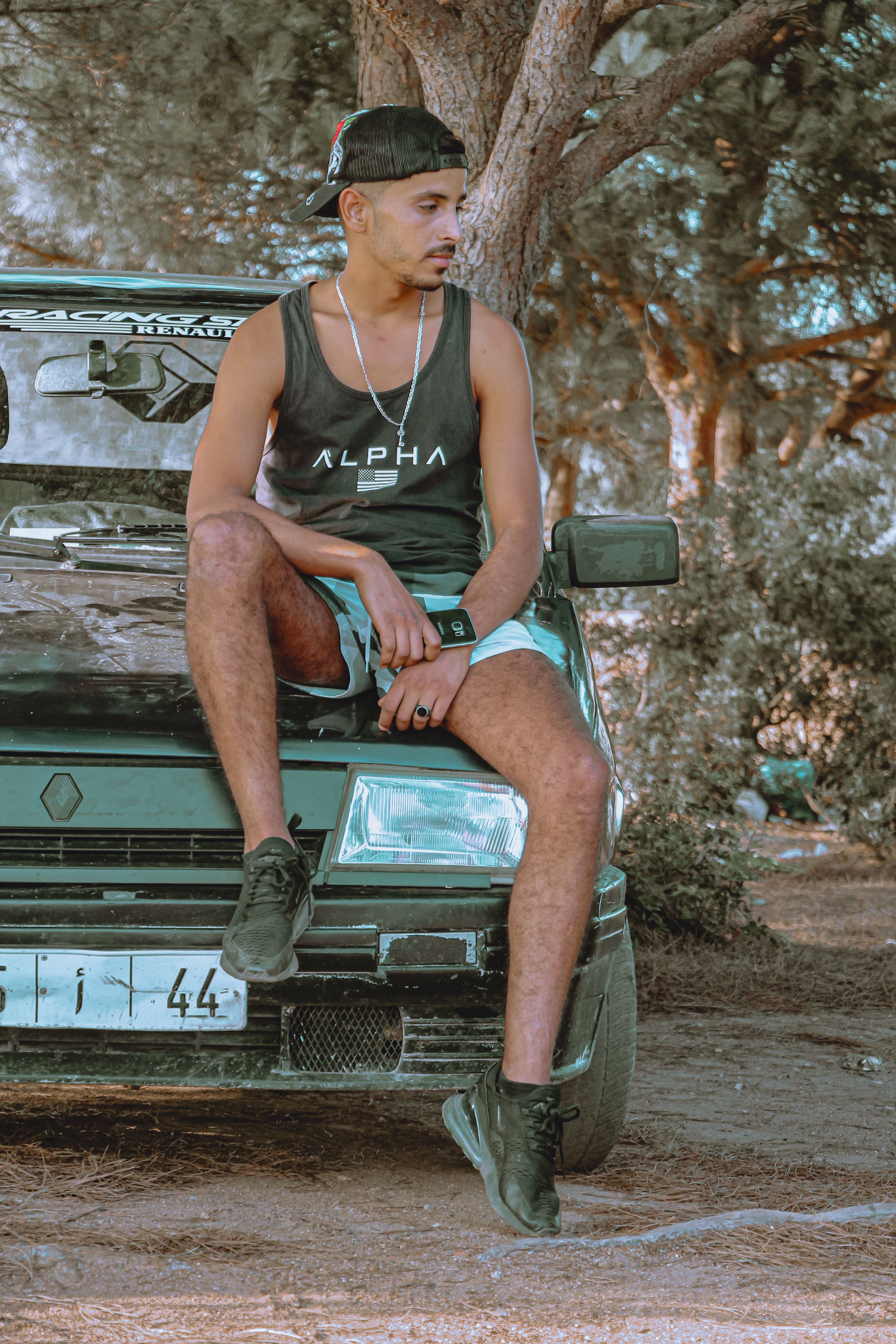Man in Tank Top Laughing inside the Car during the Night · Free Stock Photo