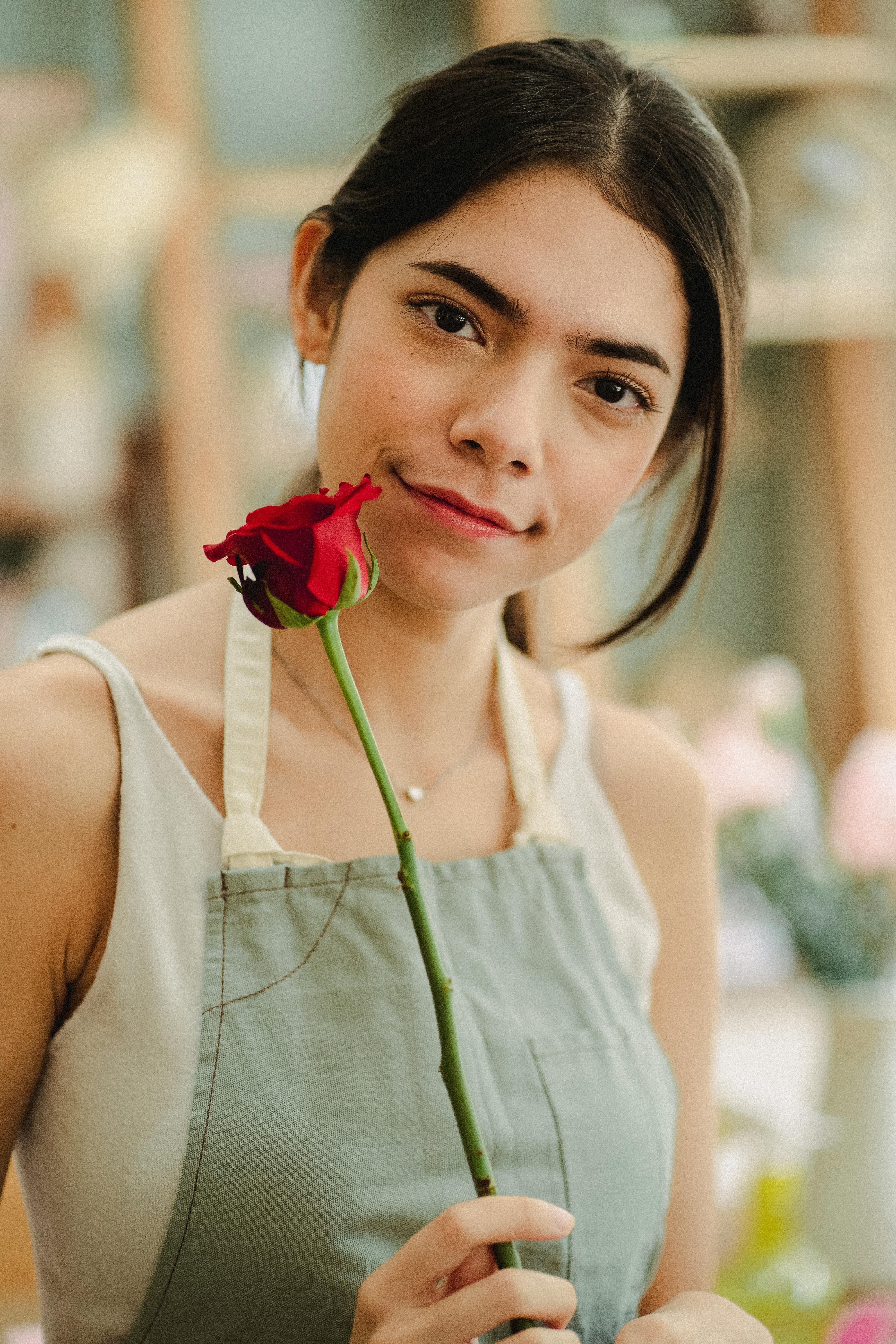 Woman with red rose in shop · Free Stock Photo