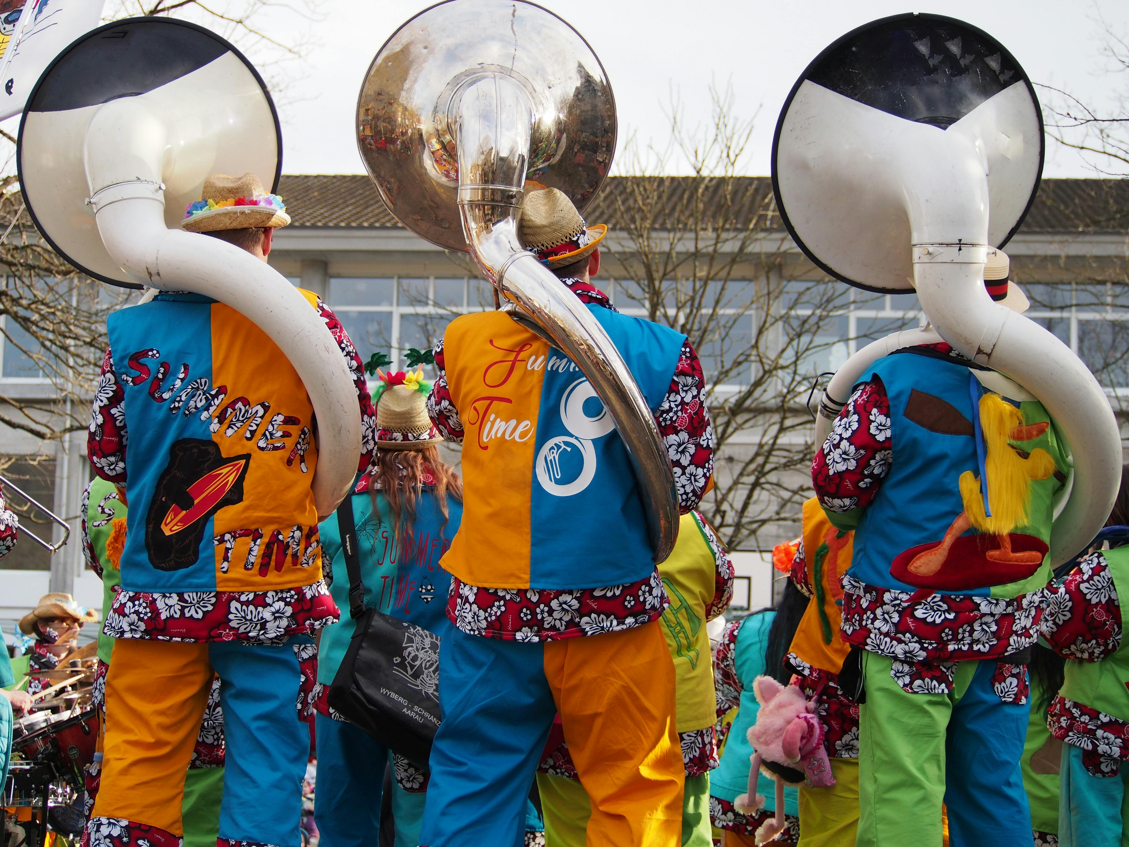 People in Blue and Orange Uniforms with Tubas · Free Stock Photo