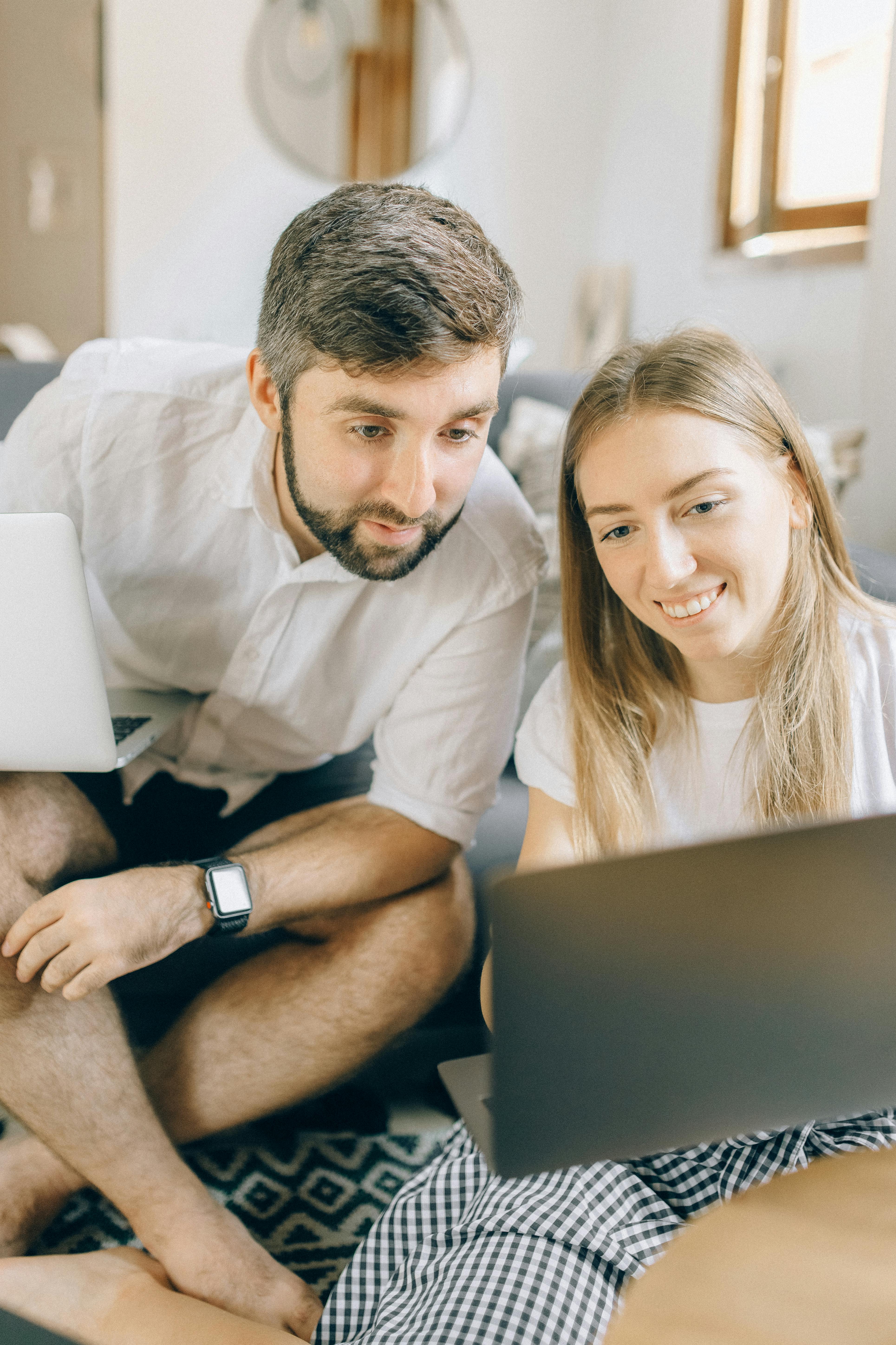Couple Looking at a Laptop · Free Stock Photo