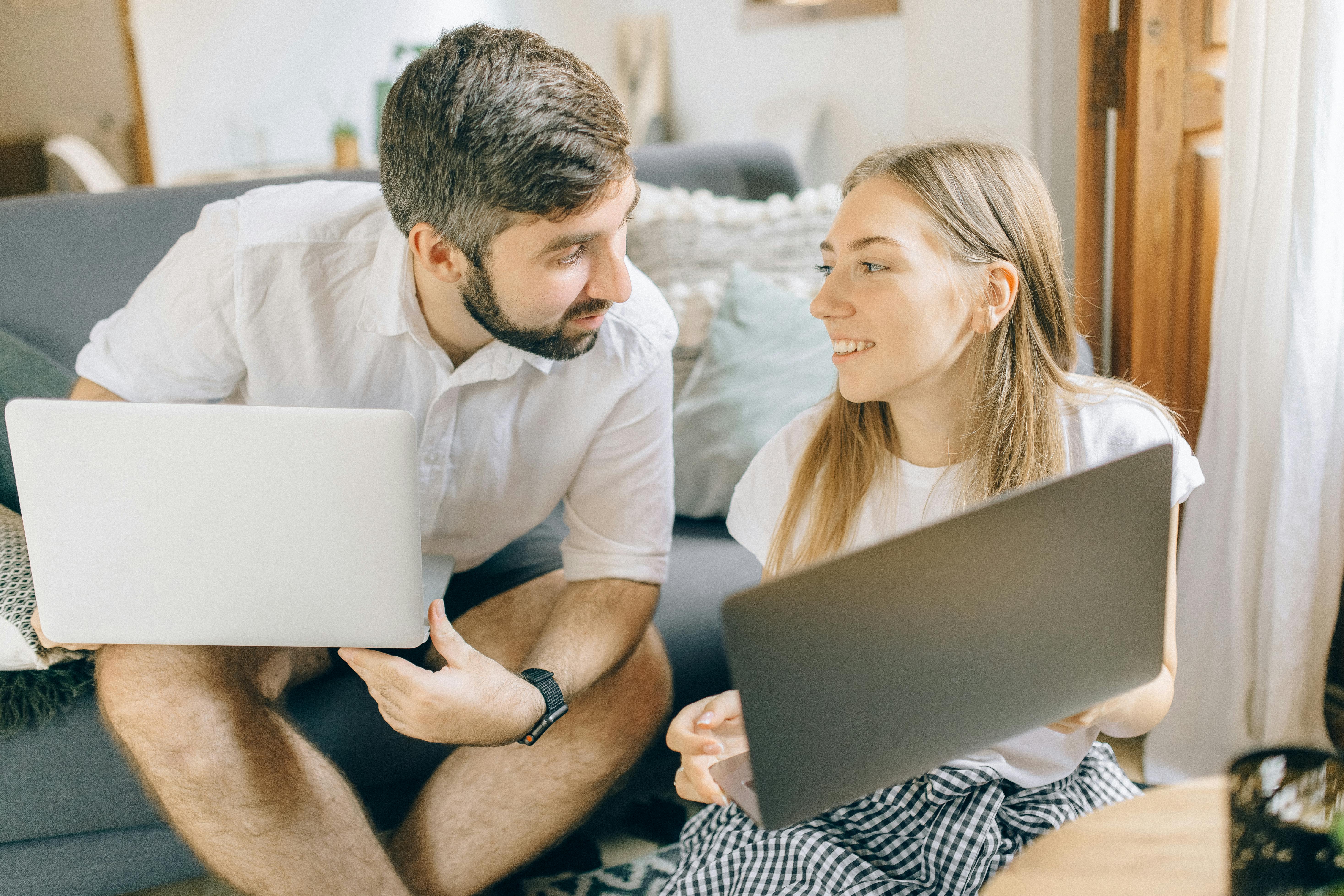 Man and Woman Holding Their Laptops · Free Stock Photo