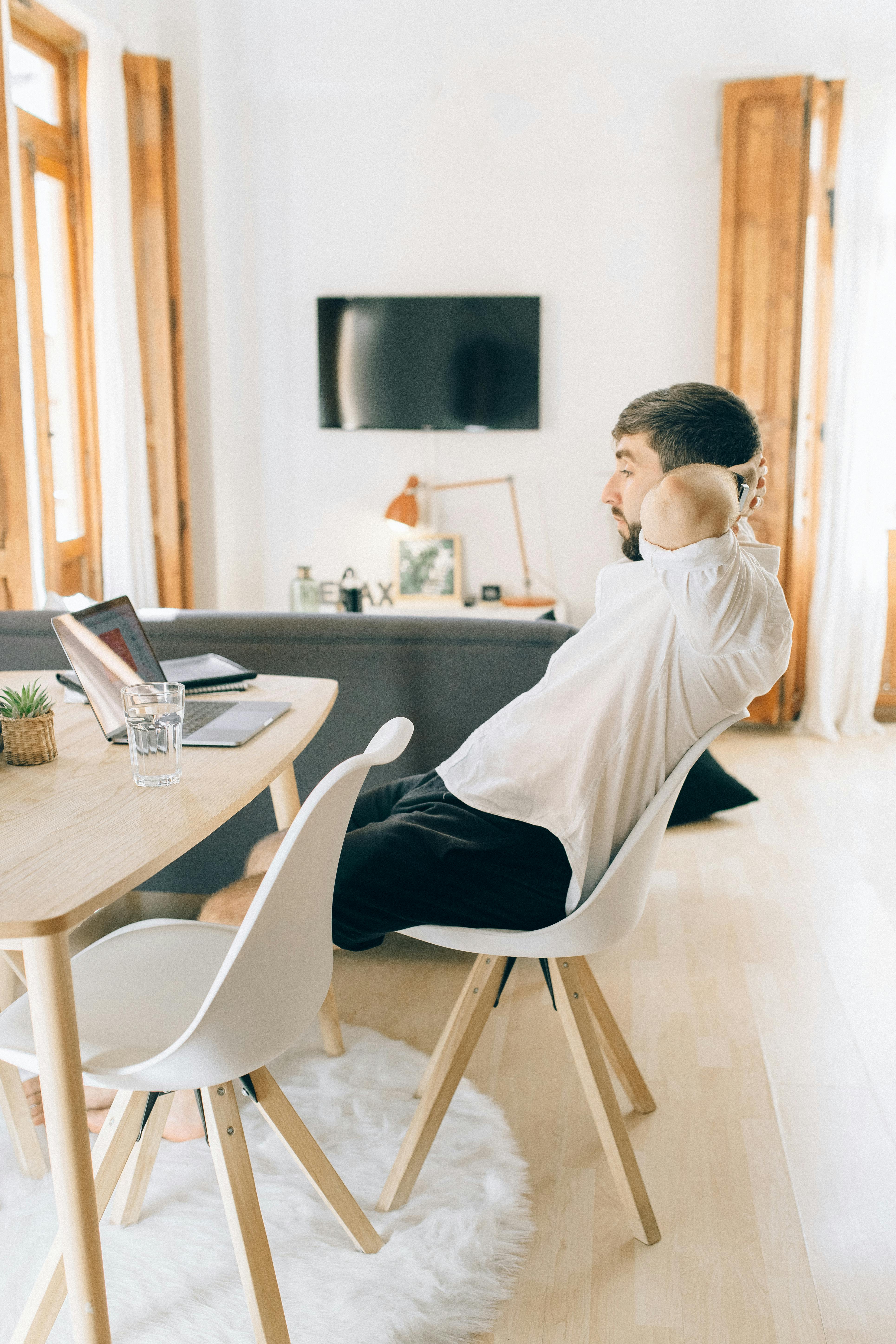 Man Sitting on Chair in Front of Table · Free Stock Photo