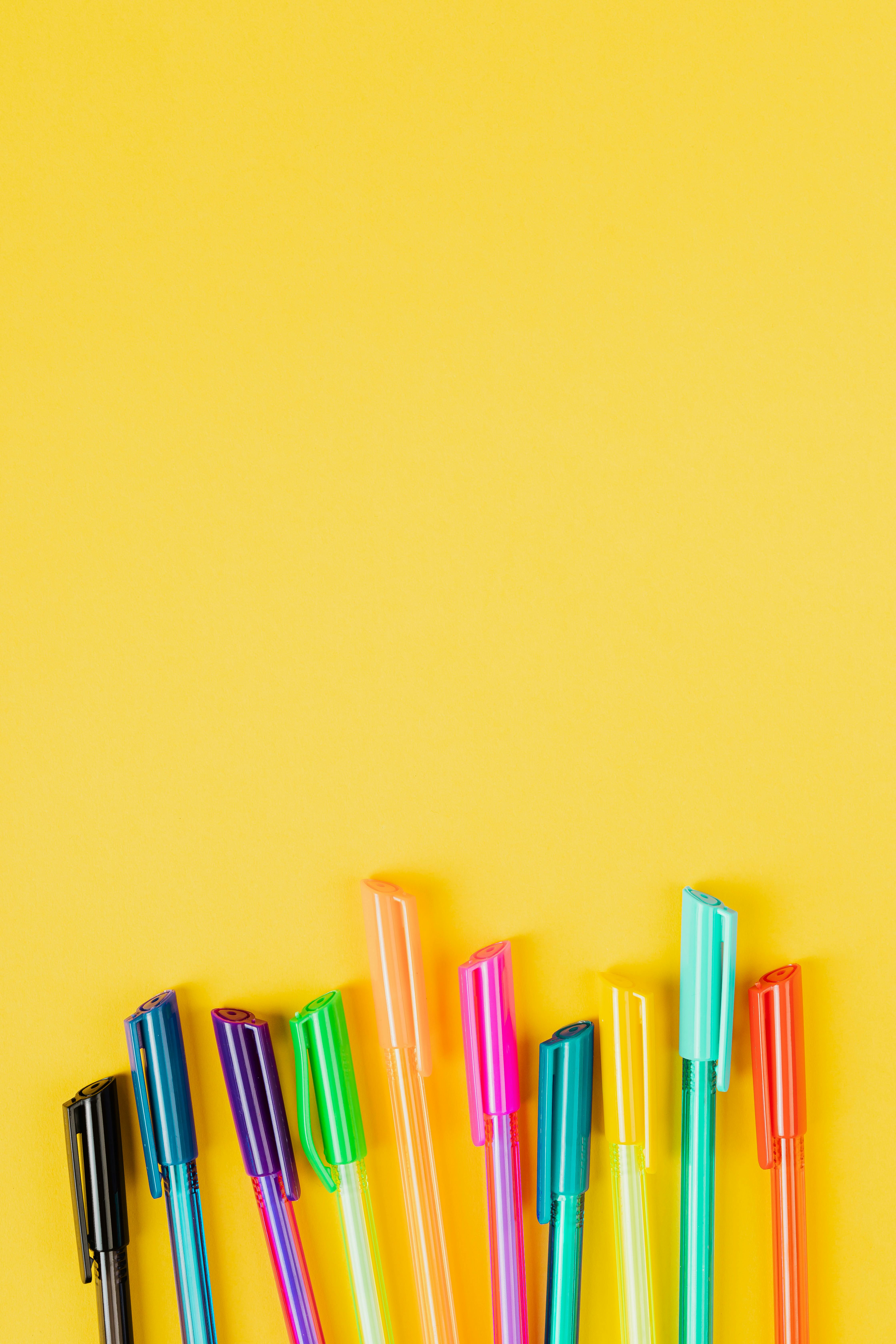 Color Pens on Yellow Background · Free Stock Photo