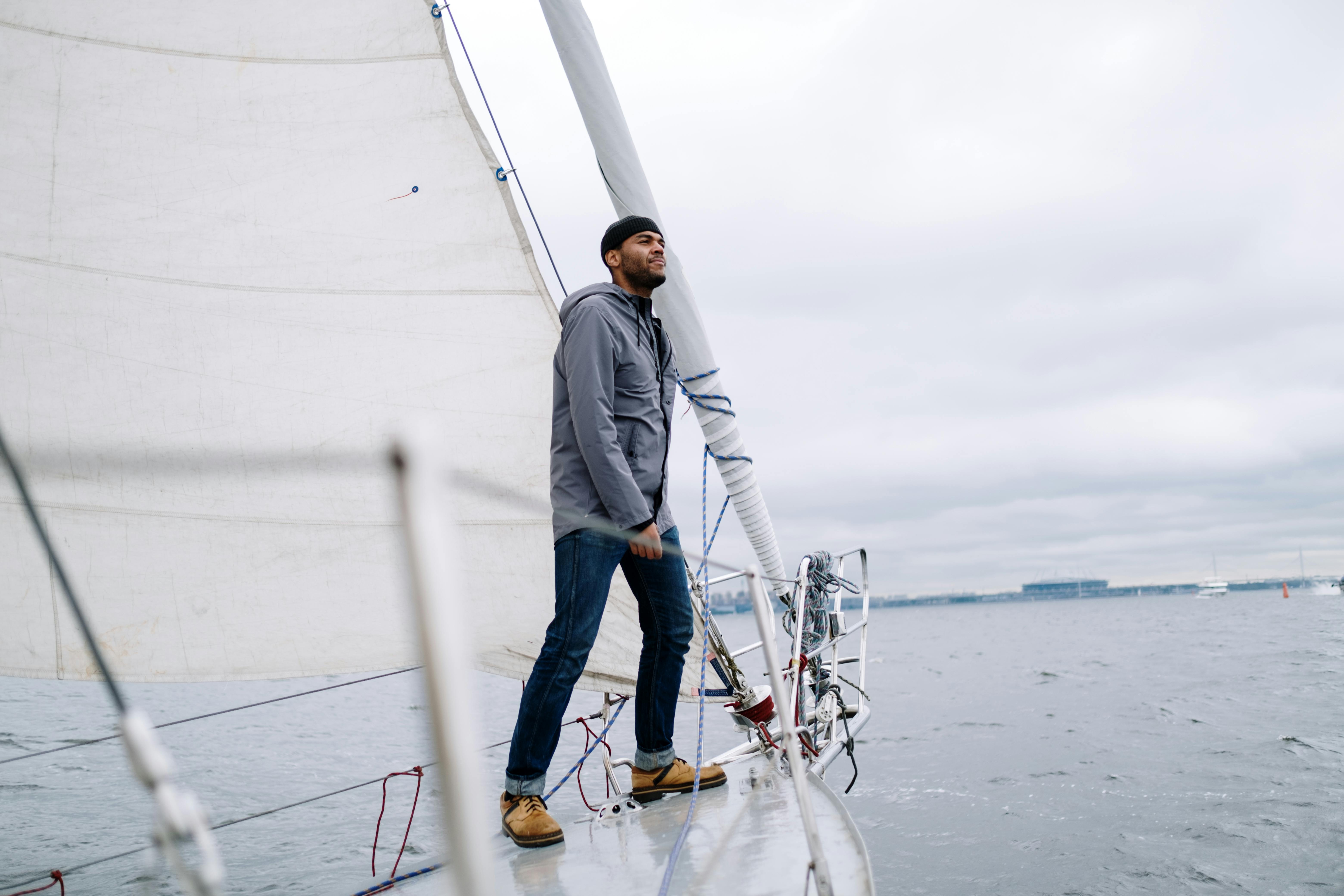 Man Standing on a Sailboat · Free Stock Photo