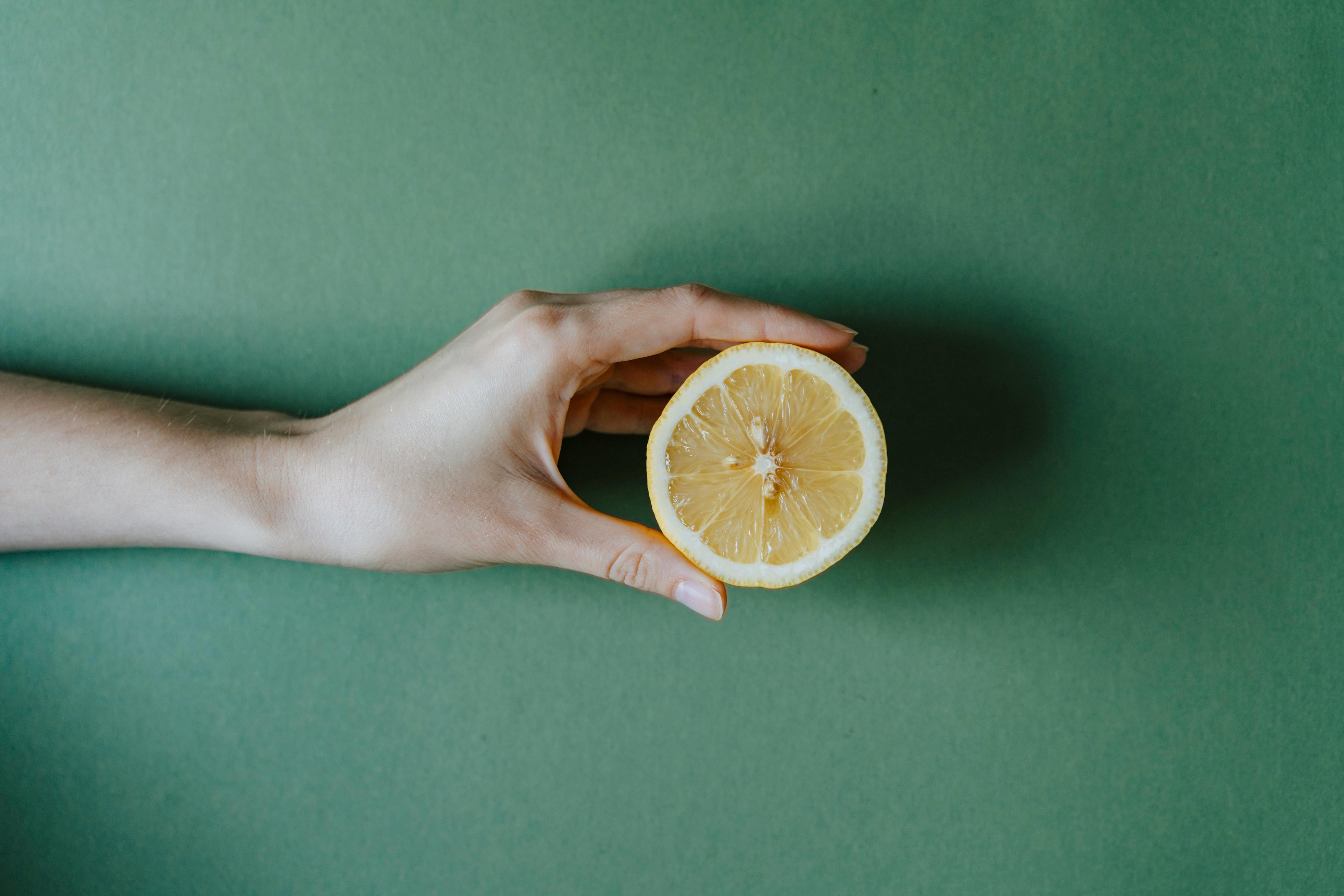 Close Up of Woman Hand Holding Lemon · Free Stock Photo