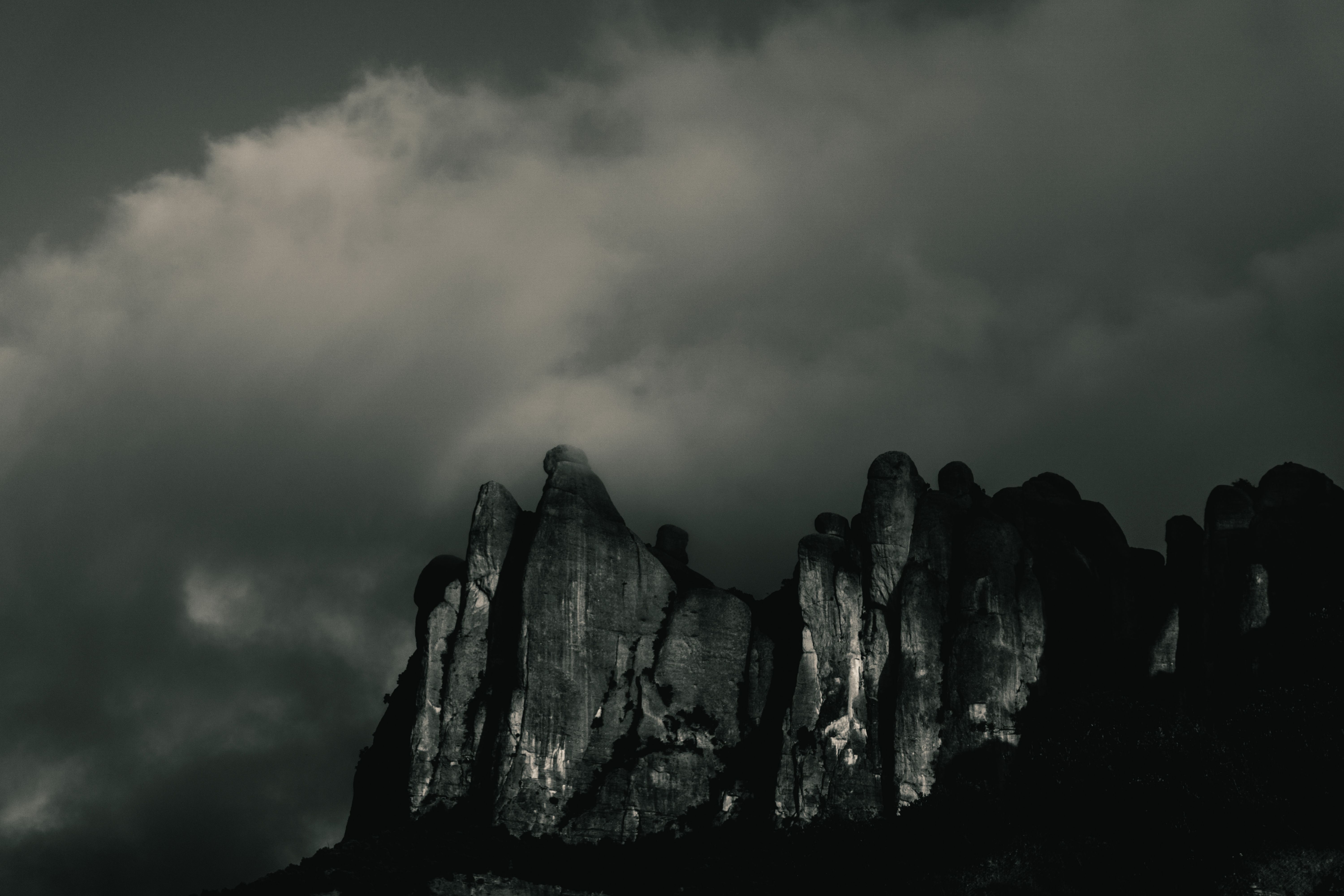 Gray Scale Photo of Leafless Tree Under Cloudy Sky · Free Stock Photo