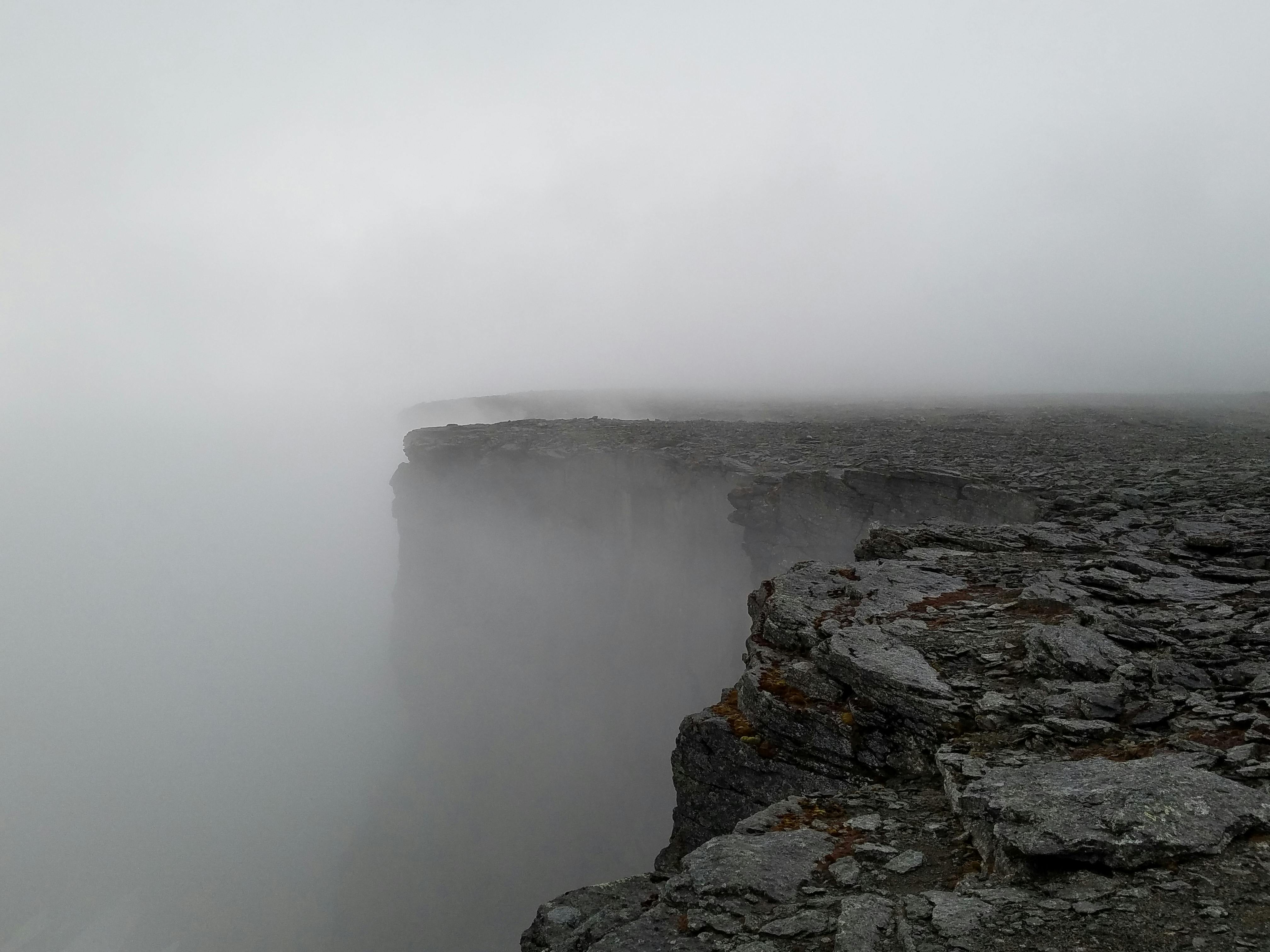 Dark Cliff Covered with Fog · Free Stock Photo