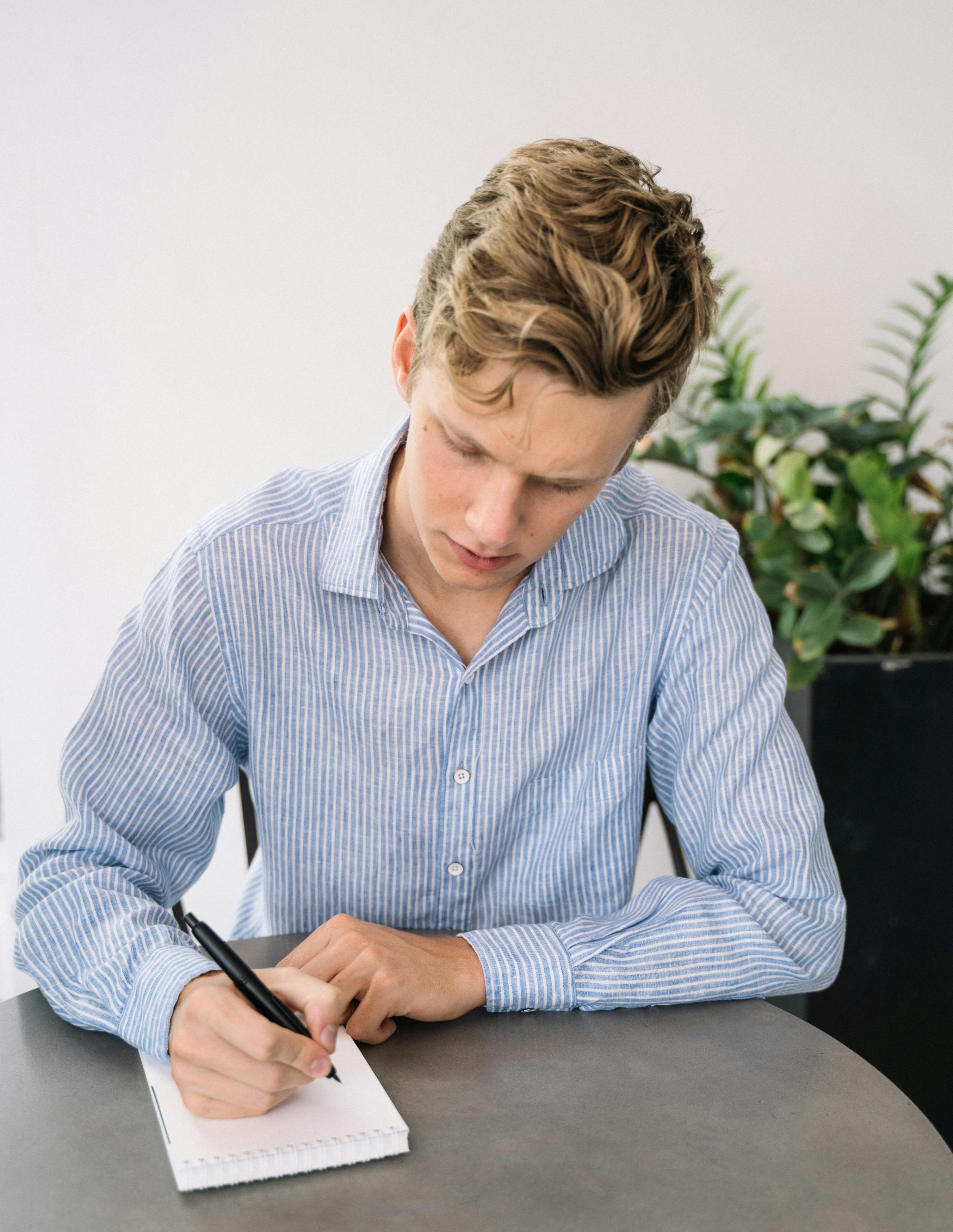 Portrait of a Young Man Taking Notes · Free Stock Photo