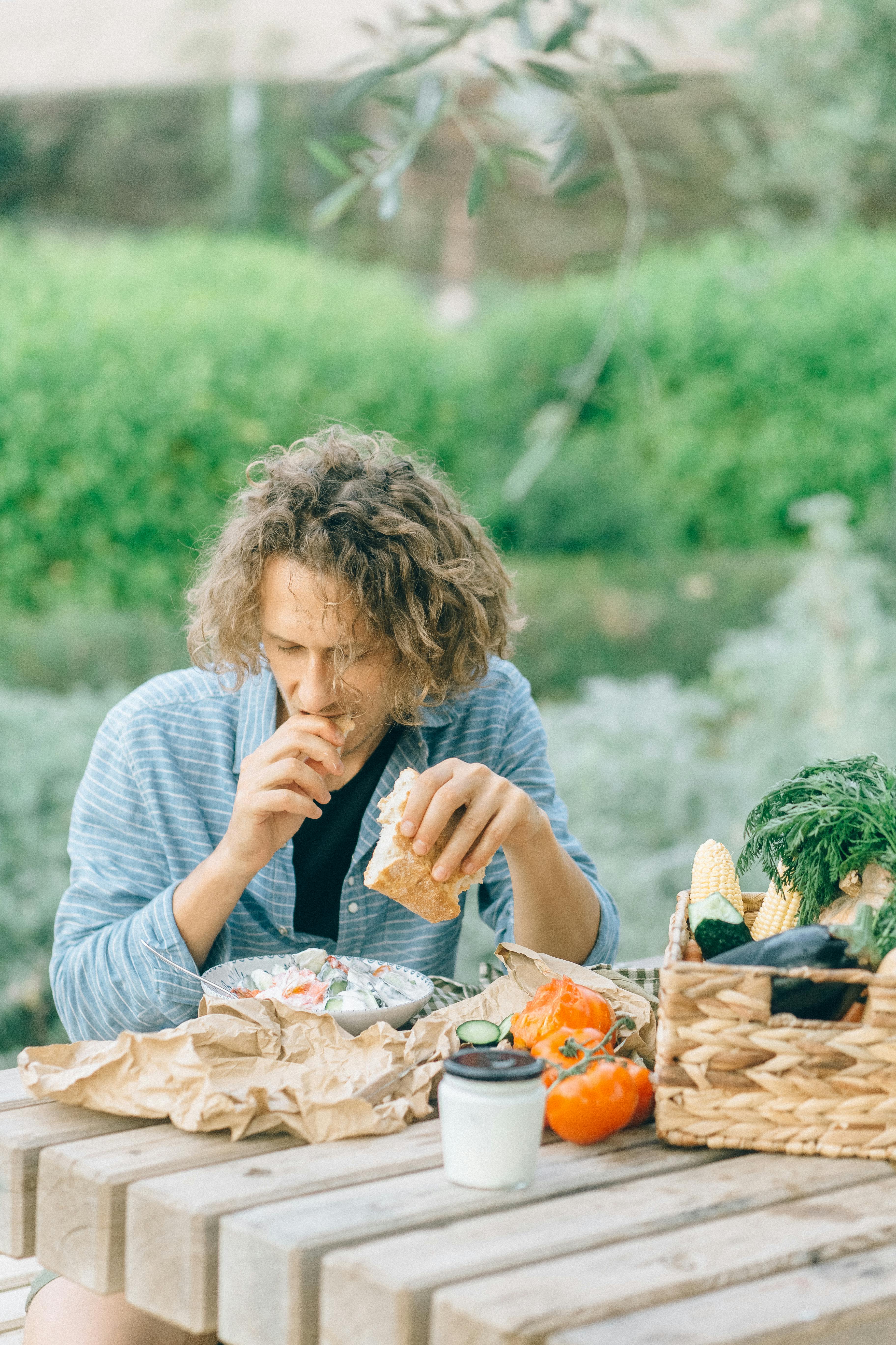 Man Eating a Piece of Bread · Free Stock Photo