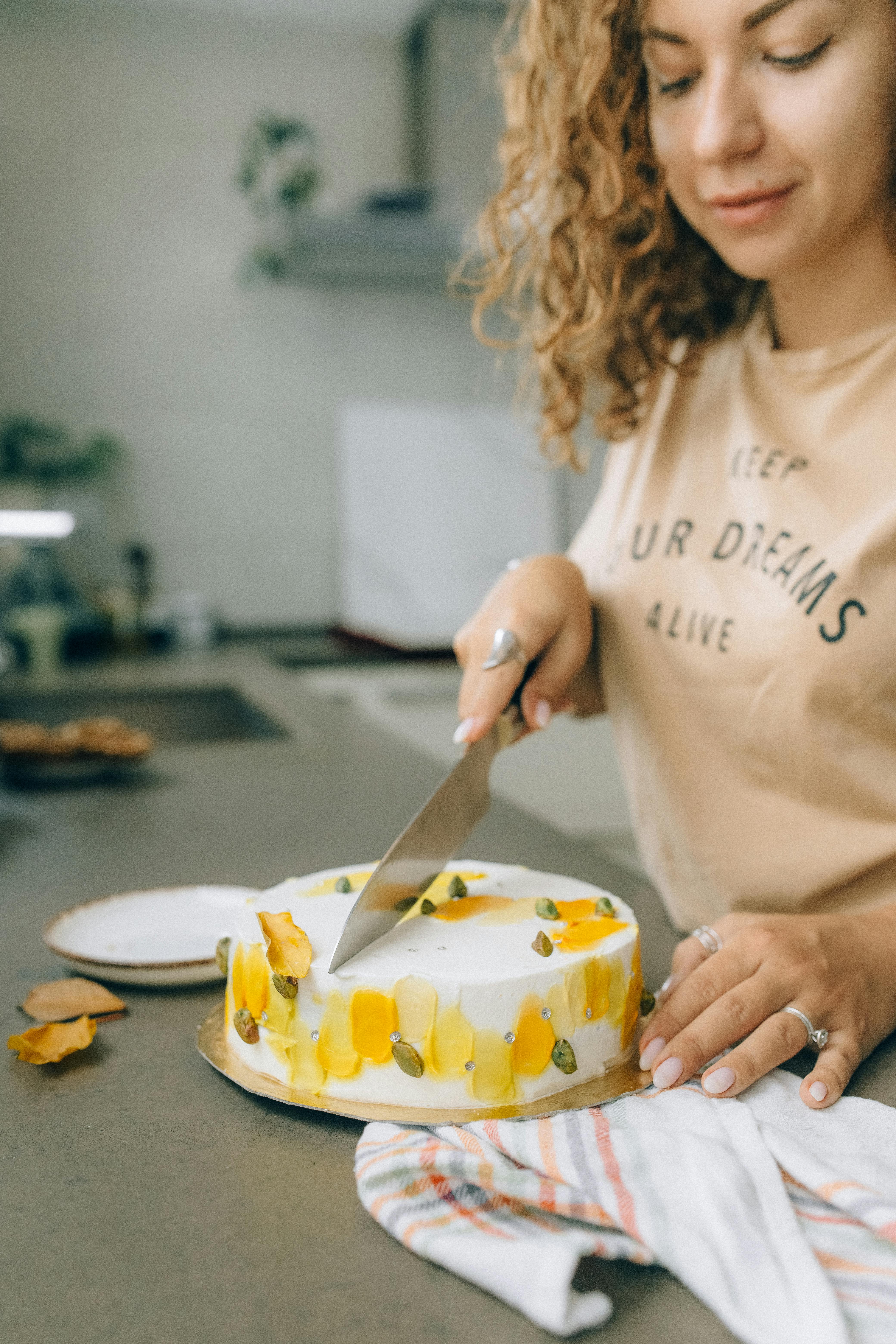 Woman Slicing a Cake · Free Stock Photo