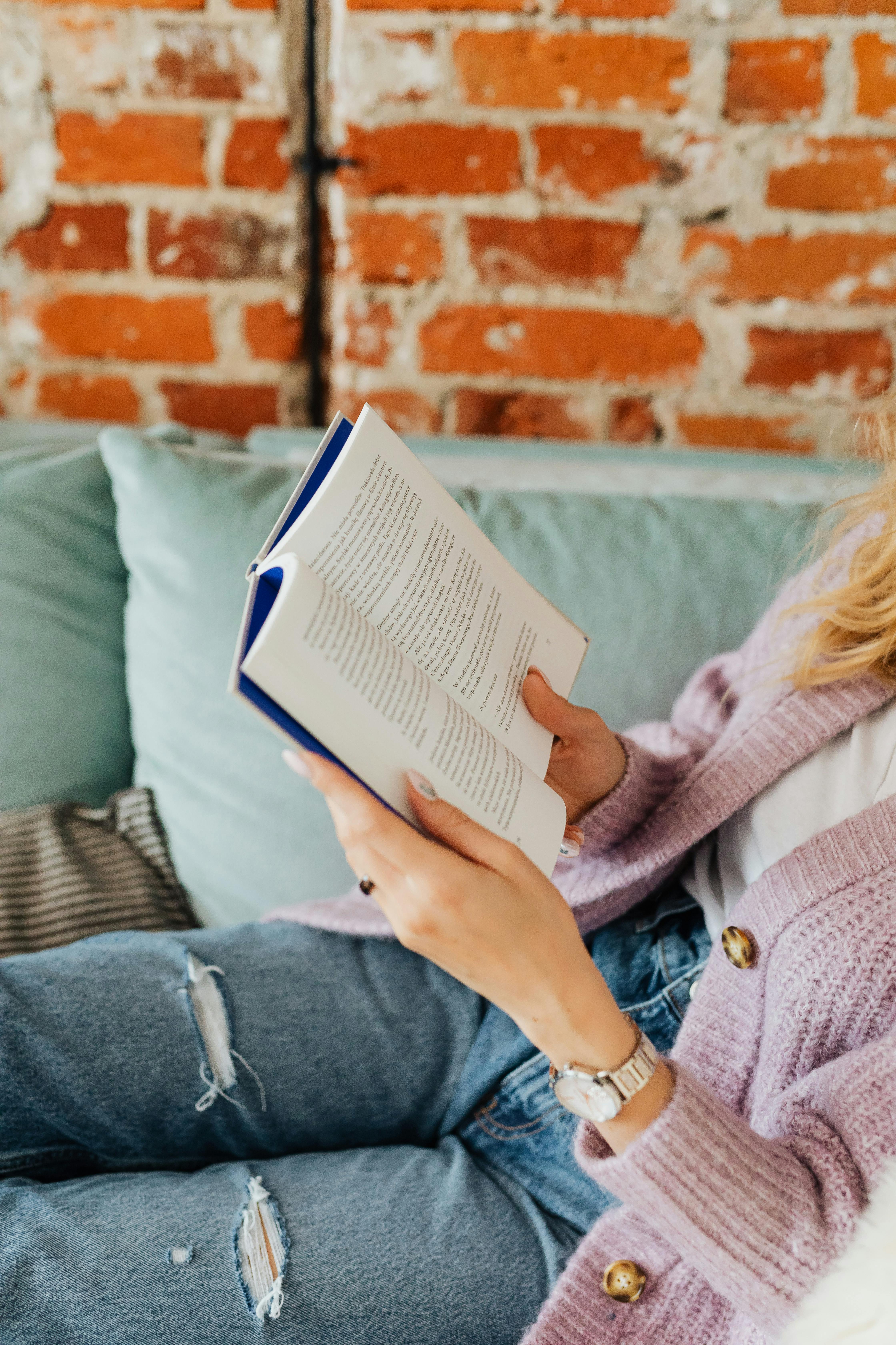 Close-Up Shot of Person Reading a Book · Free Stock Photo