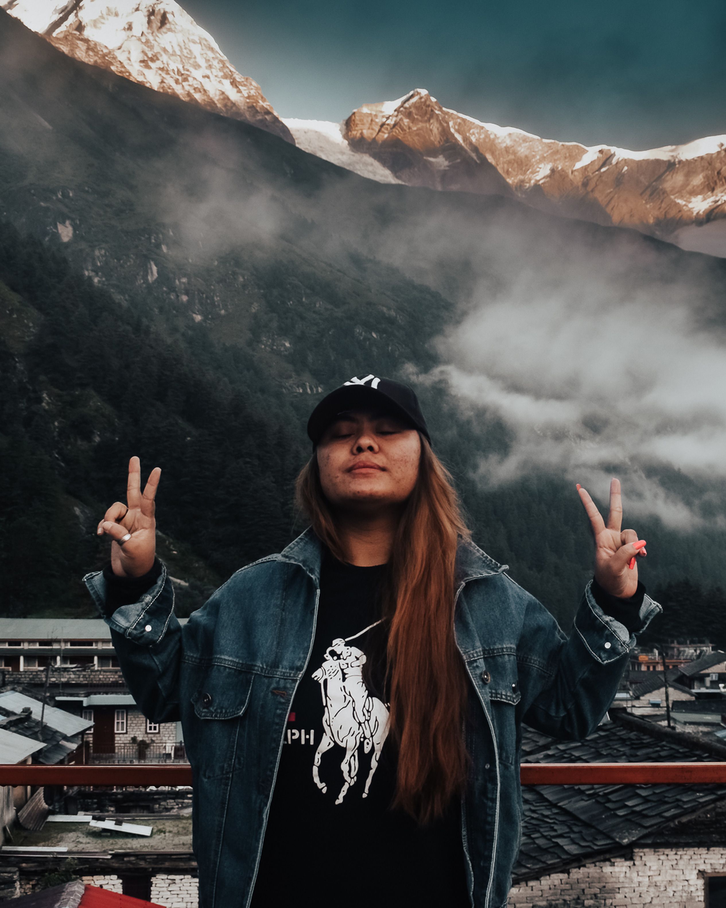 Woman in Black Denim Jacket doing a Peace Sign · Free Stock Photo