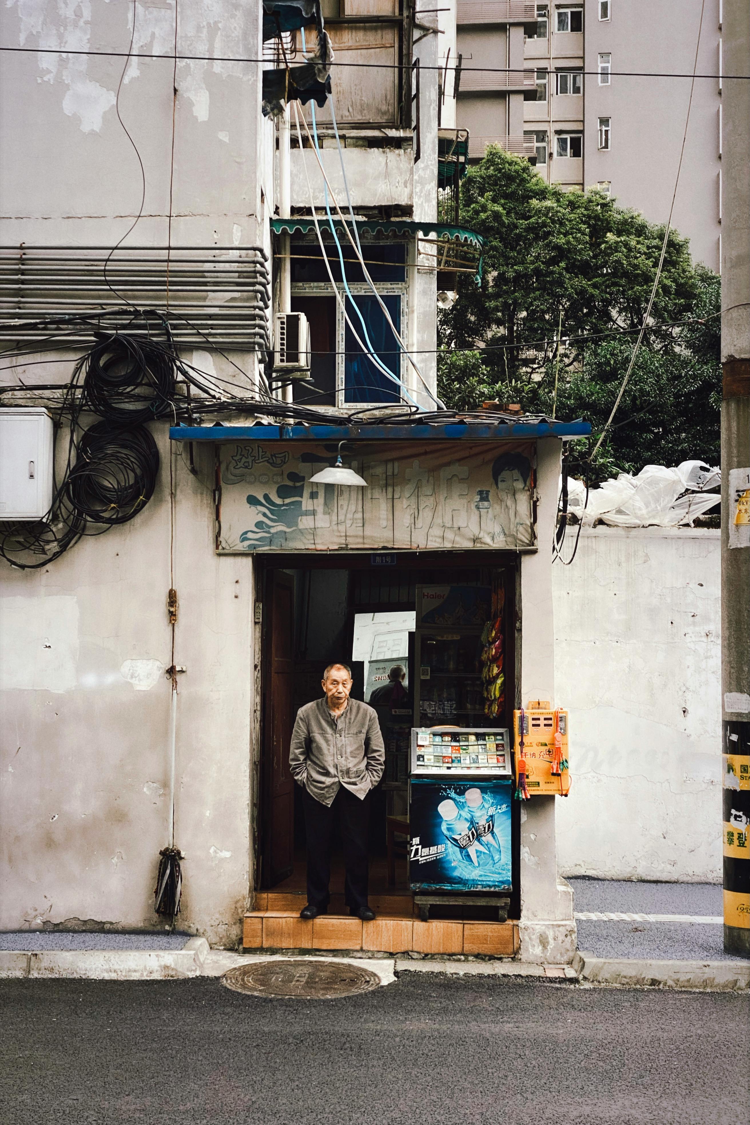 Man Standing in front of Store on City Street · Free Stock Photo