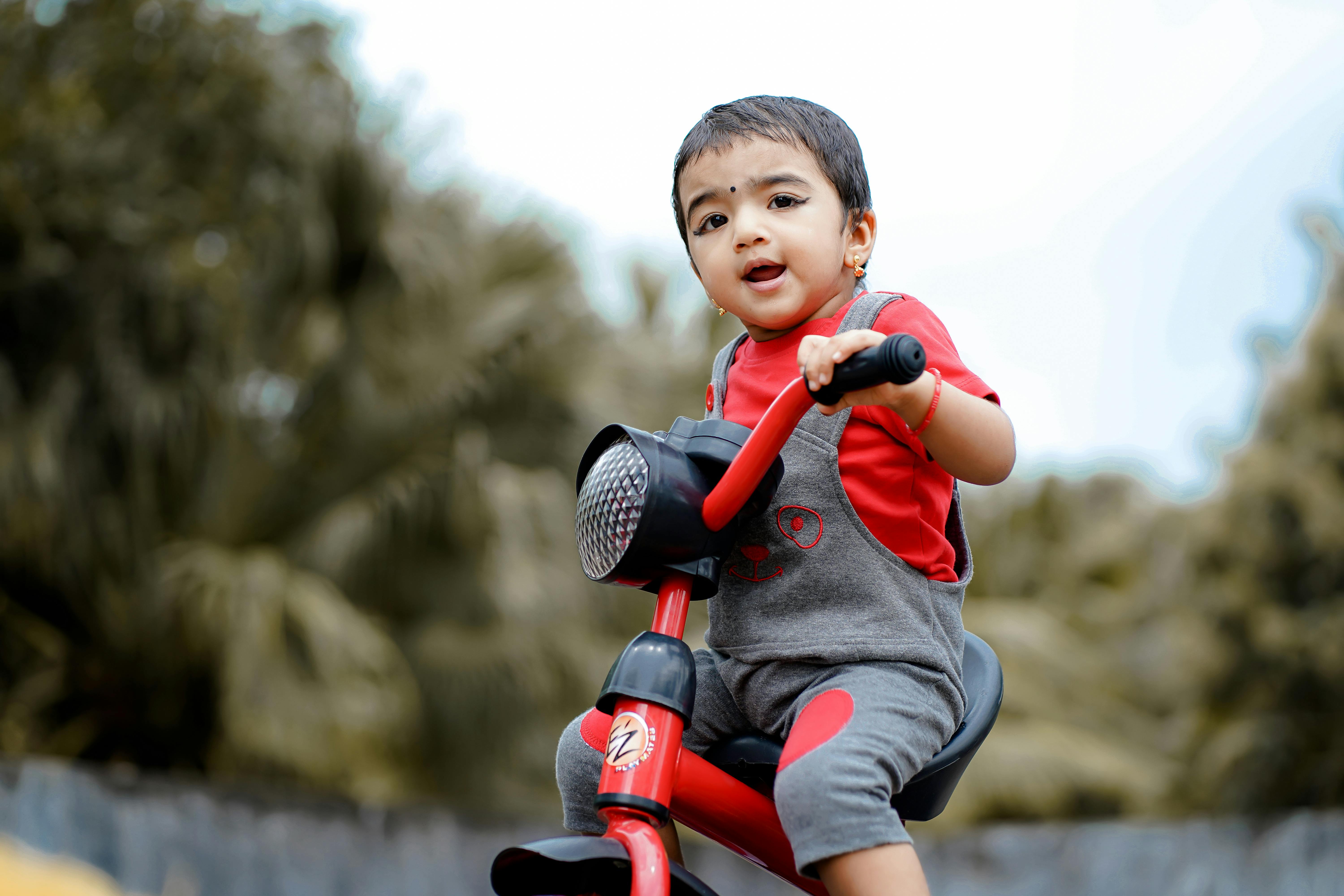 Cute Child riding a Toy Scooter · Free Stock Photo