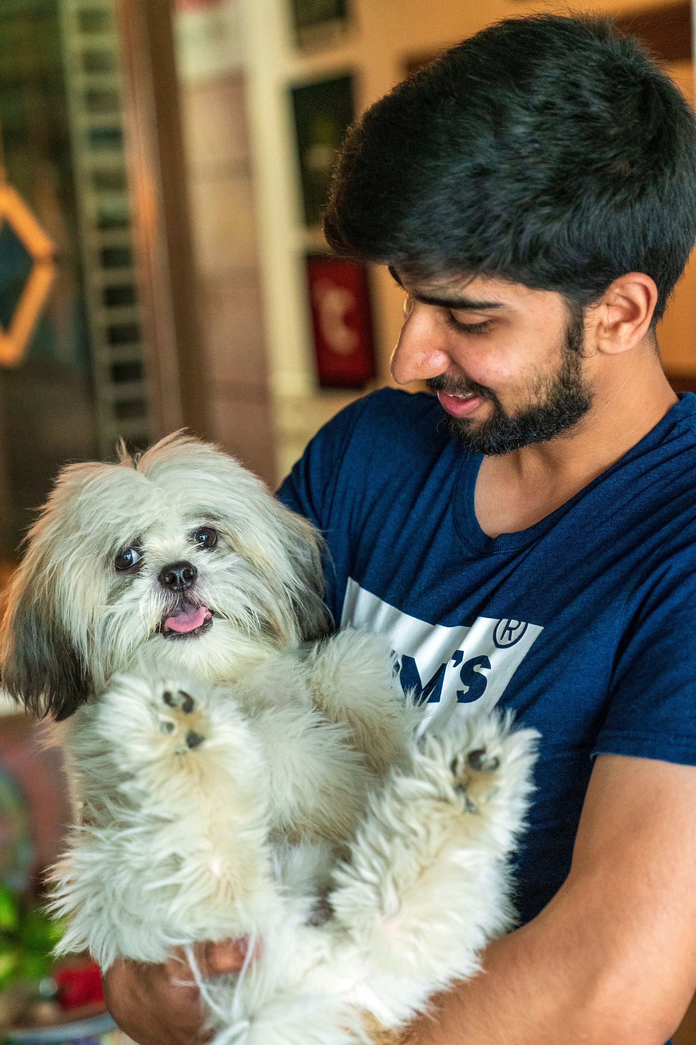 Man carrying his Cute Dog · Free Stock Photo