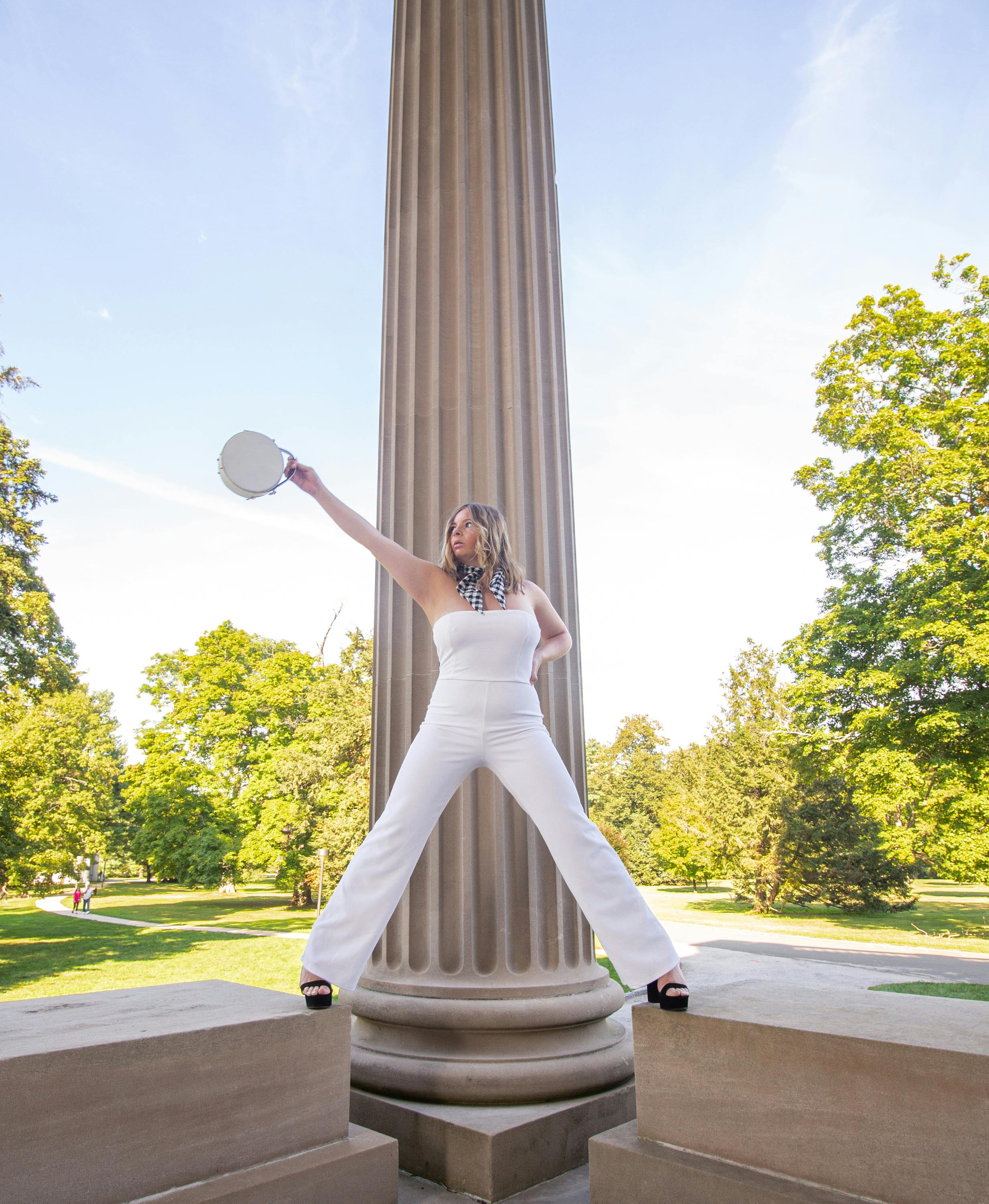 Woman in White Suit Standing with Wide Open Legs · Free Stock Photo