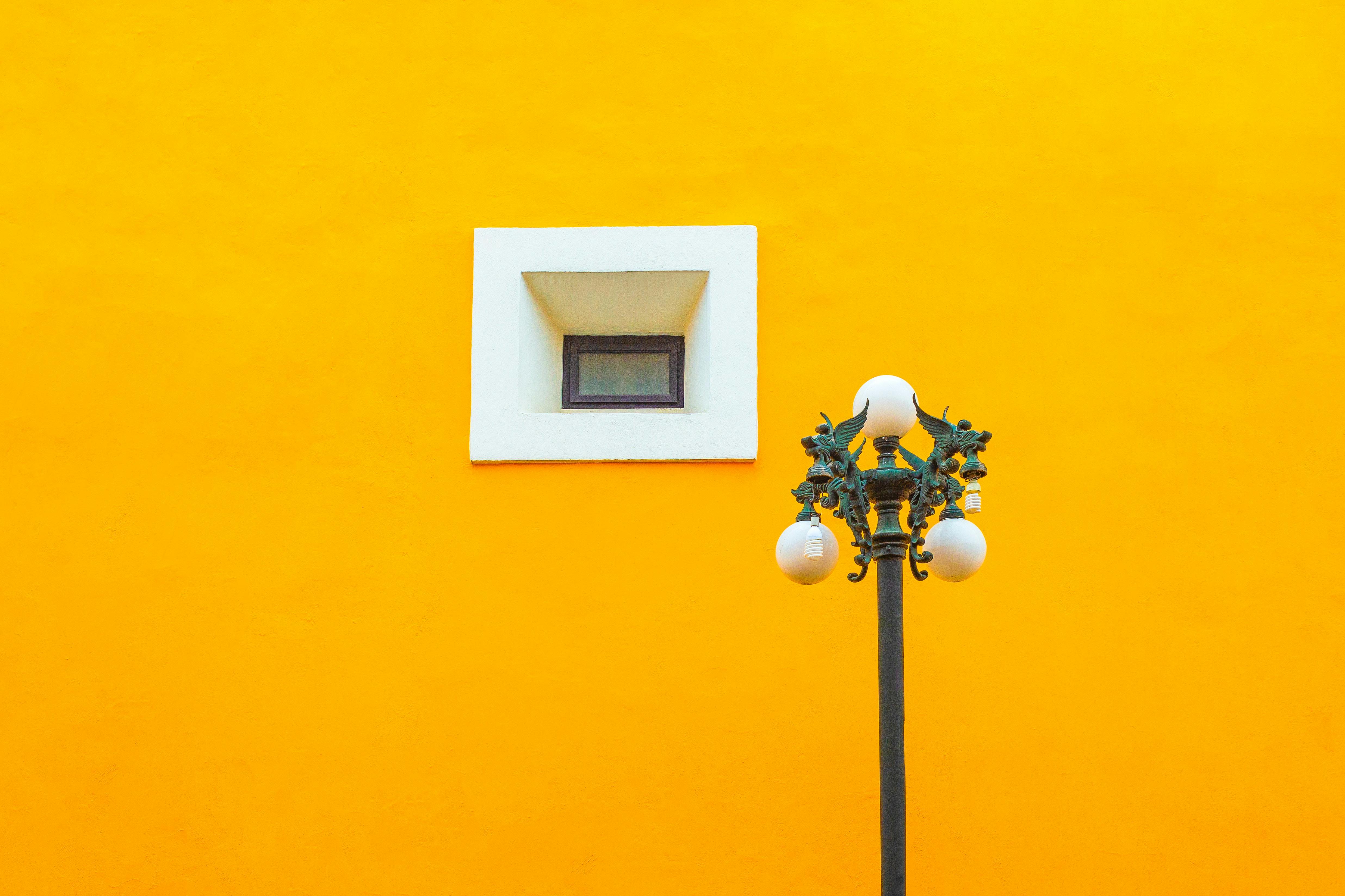 Yellow wall with small window · Free Stock Photo