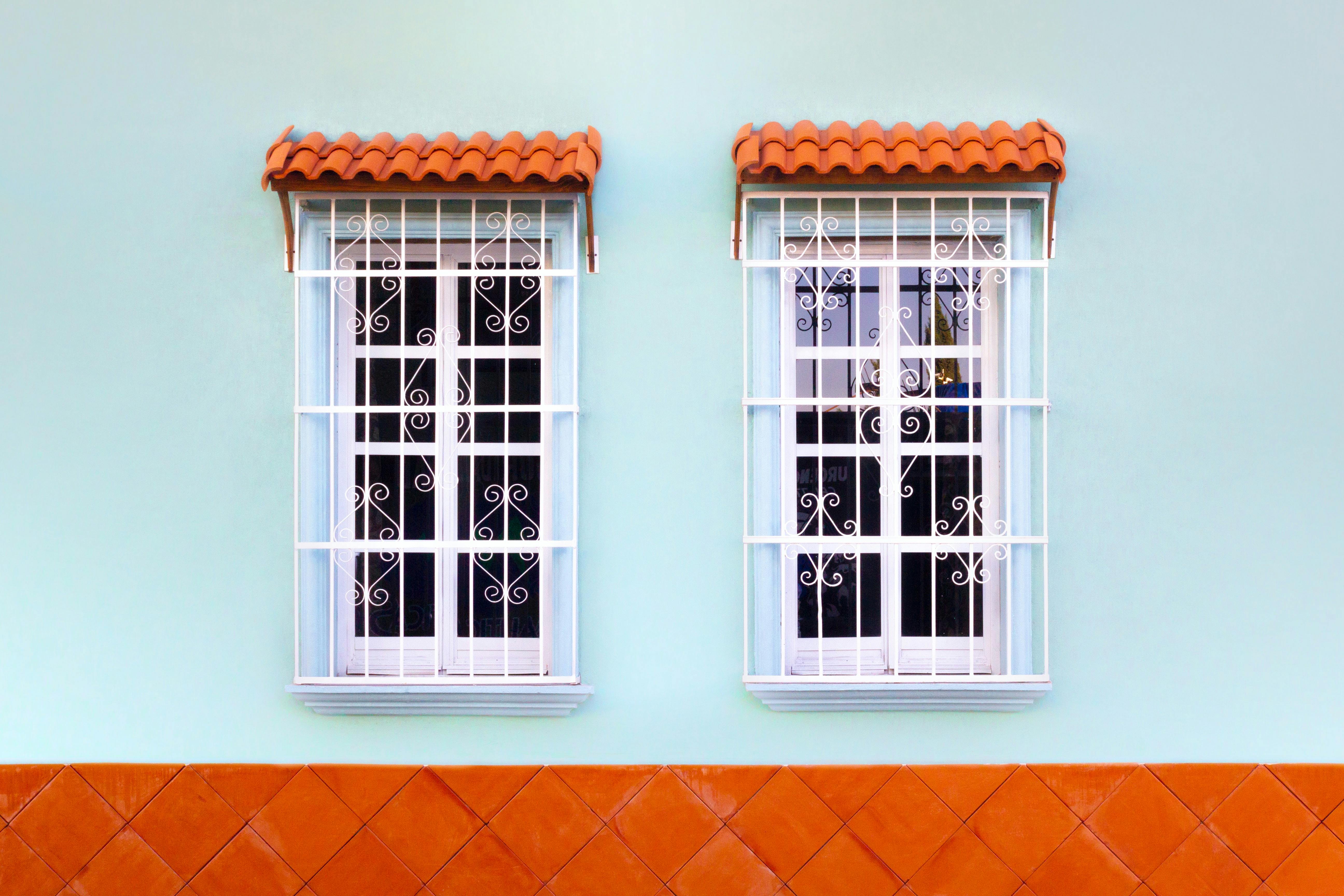 Wall of building with bars on windows · Free Stock Photo