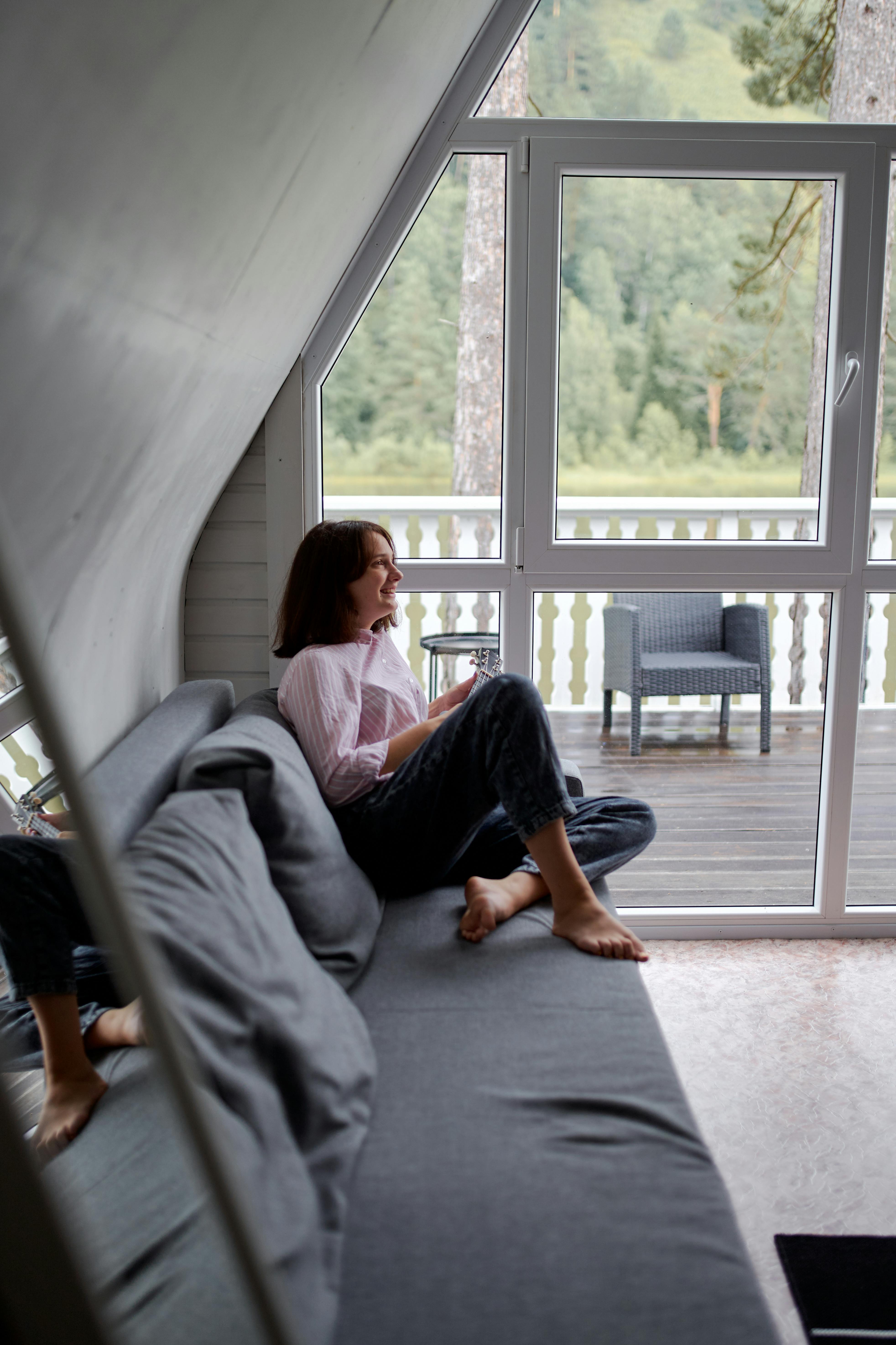 Gorgeous woman chilling on sofa in room · Free Stock Photo