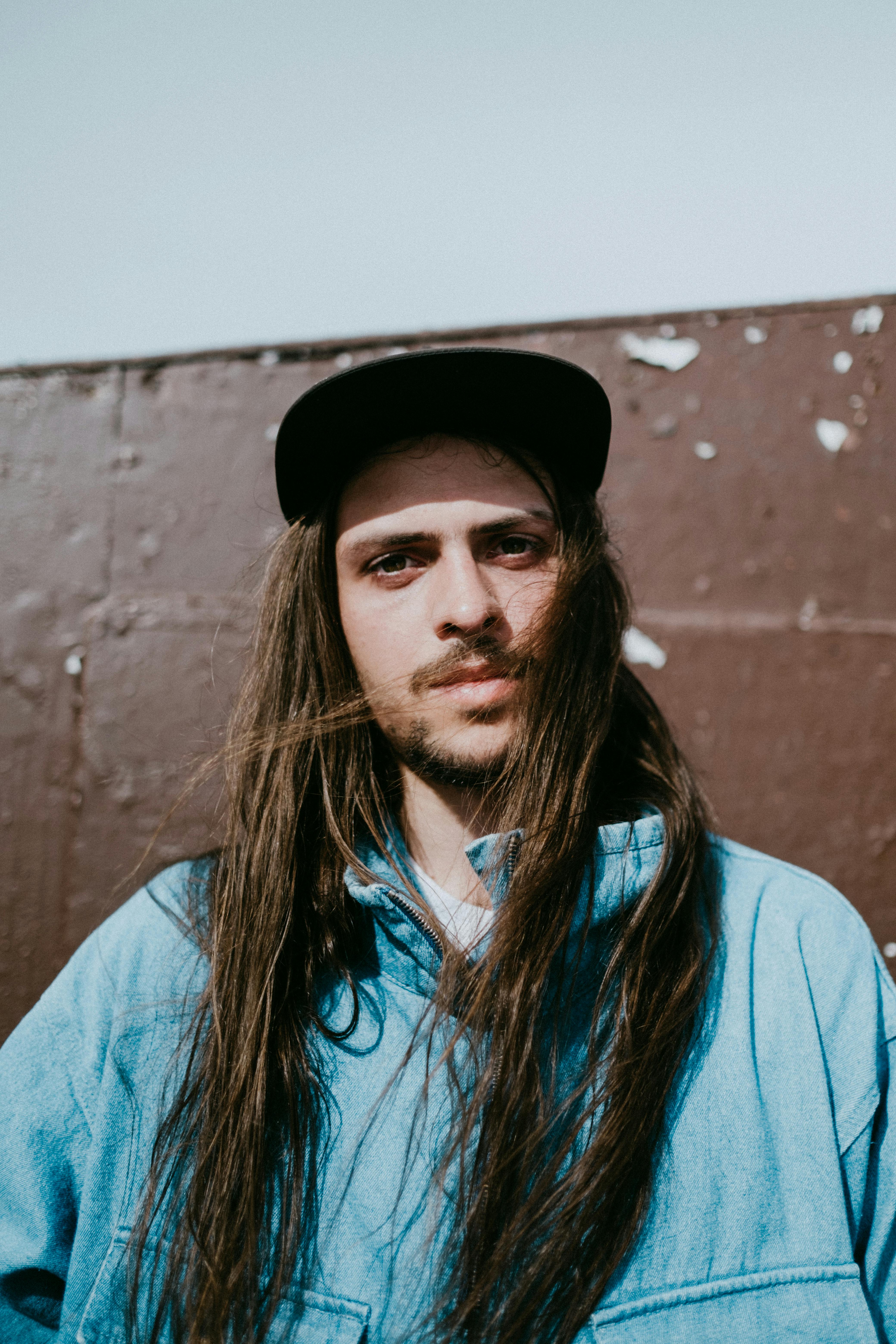 A Long Haired Man Wearing a Cap · Free Stock Photo