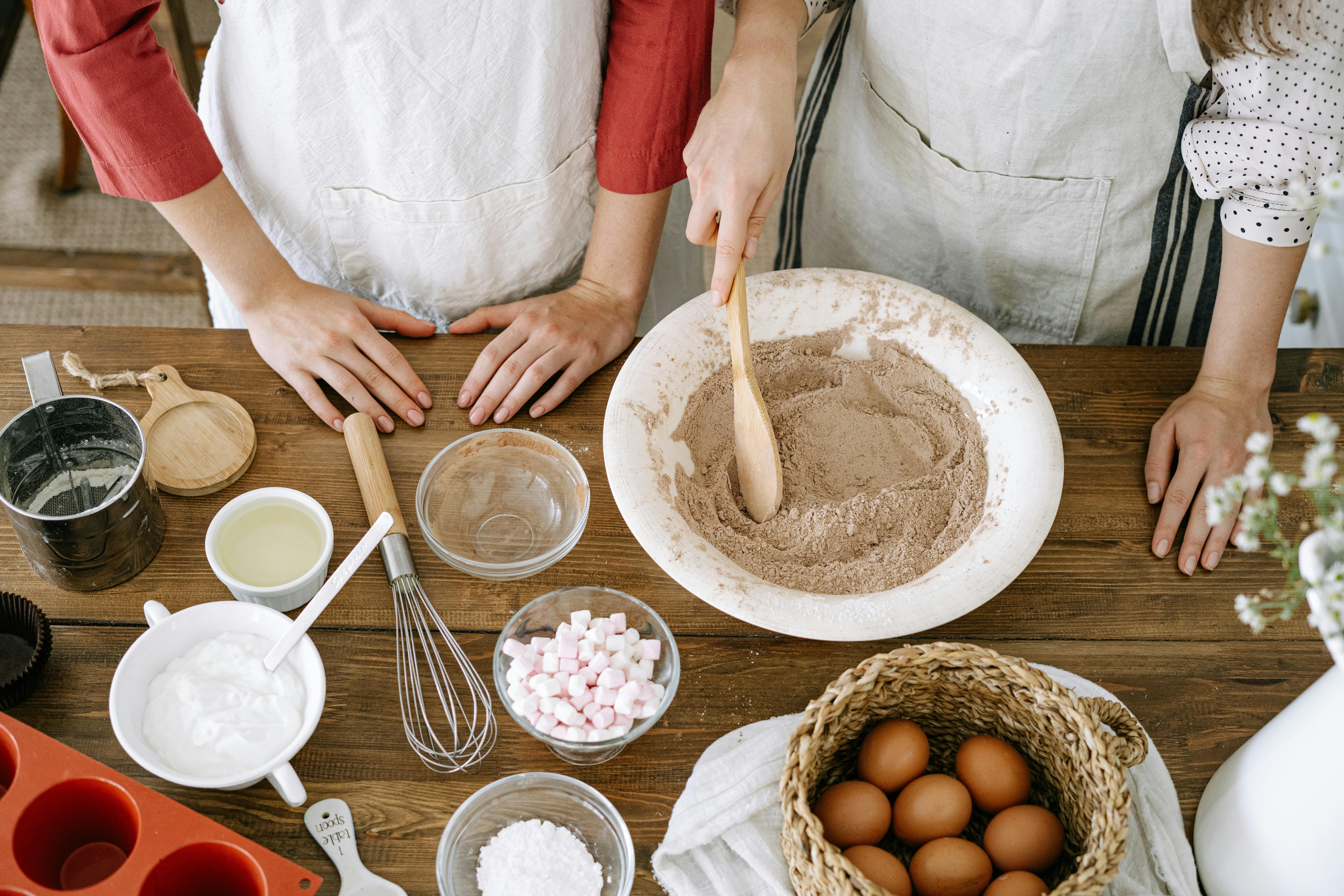 Sisters Baking on the Table · Free Stock Photo